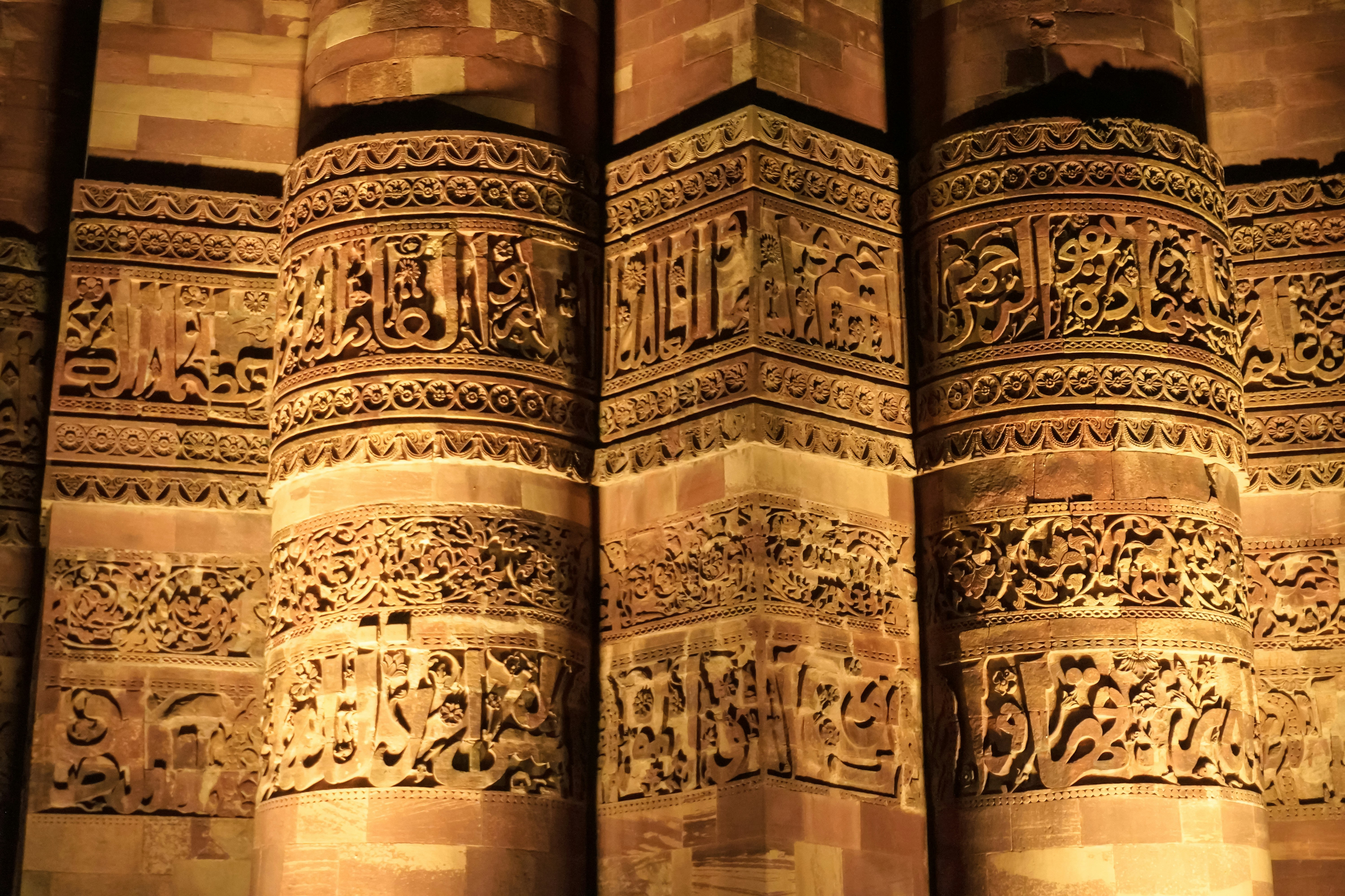 Carved stone columns: a repeating pattern of ornate inscriptions