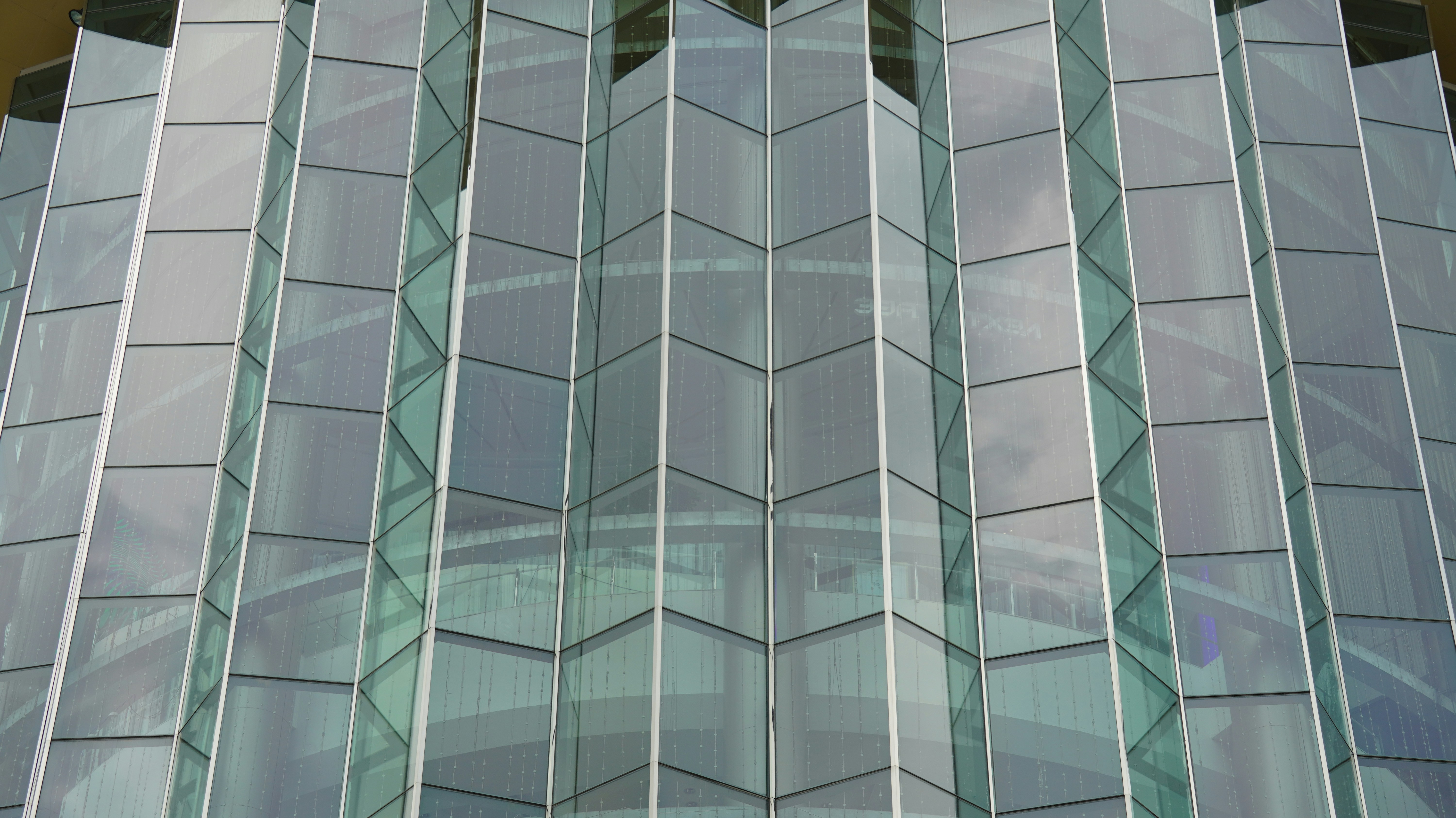 Geometric Facade: Glass Facets Refracting Skylight