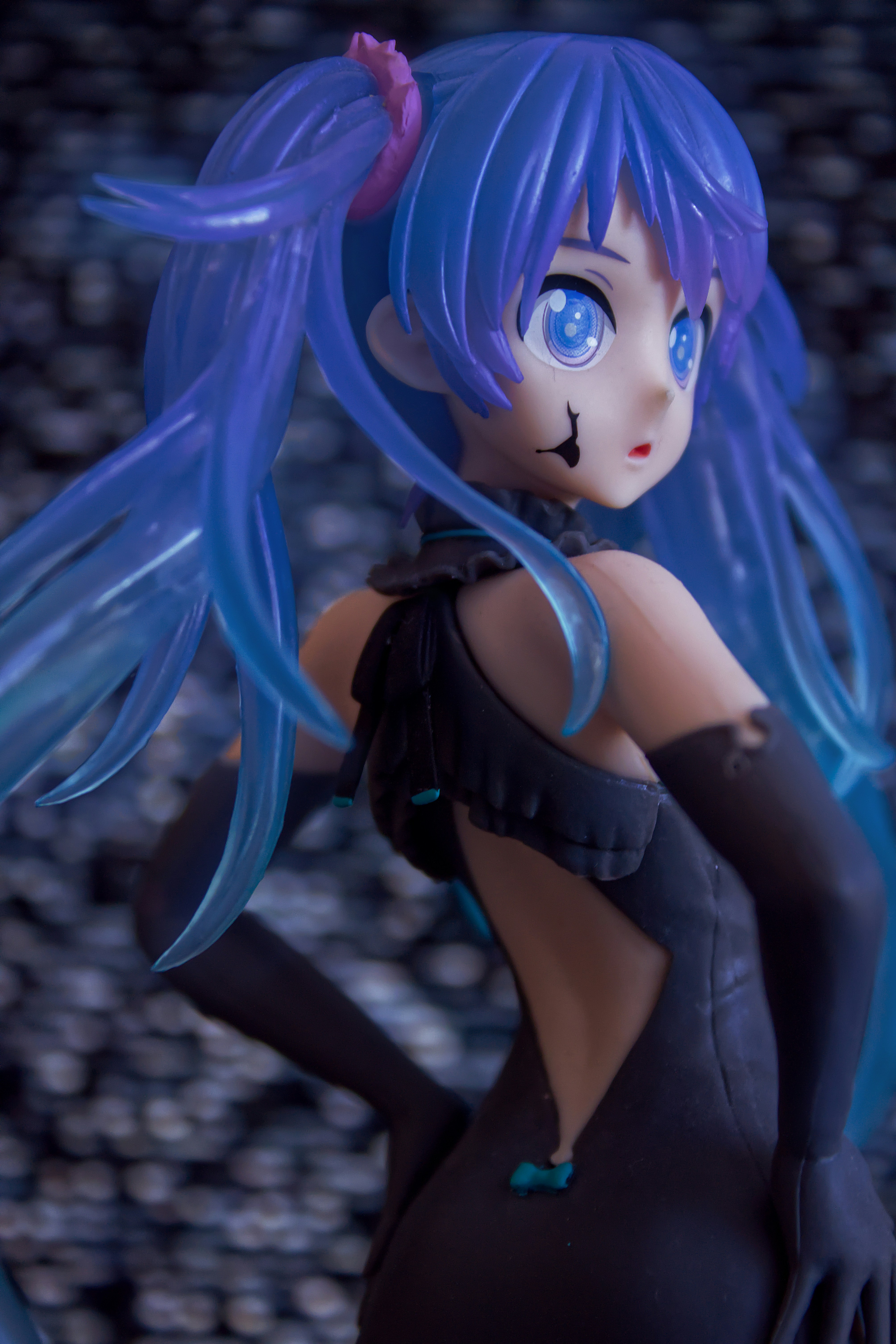 Blue-Haired Mirage: A Close-Up on a Figurine's Piercing Gaze