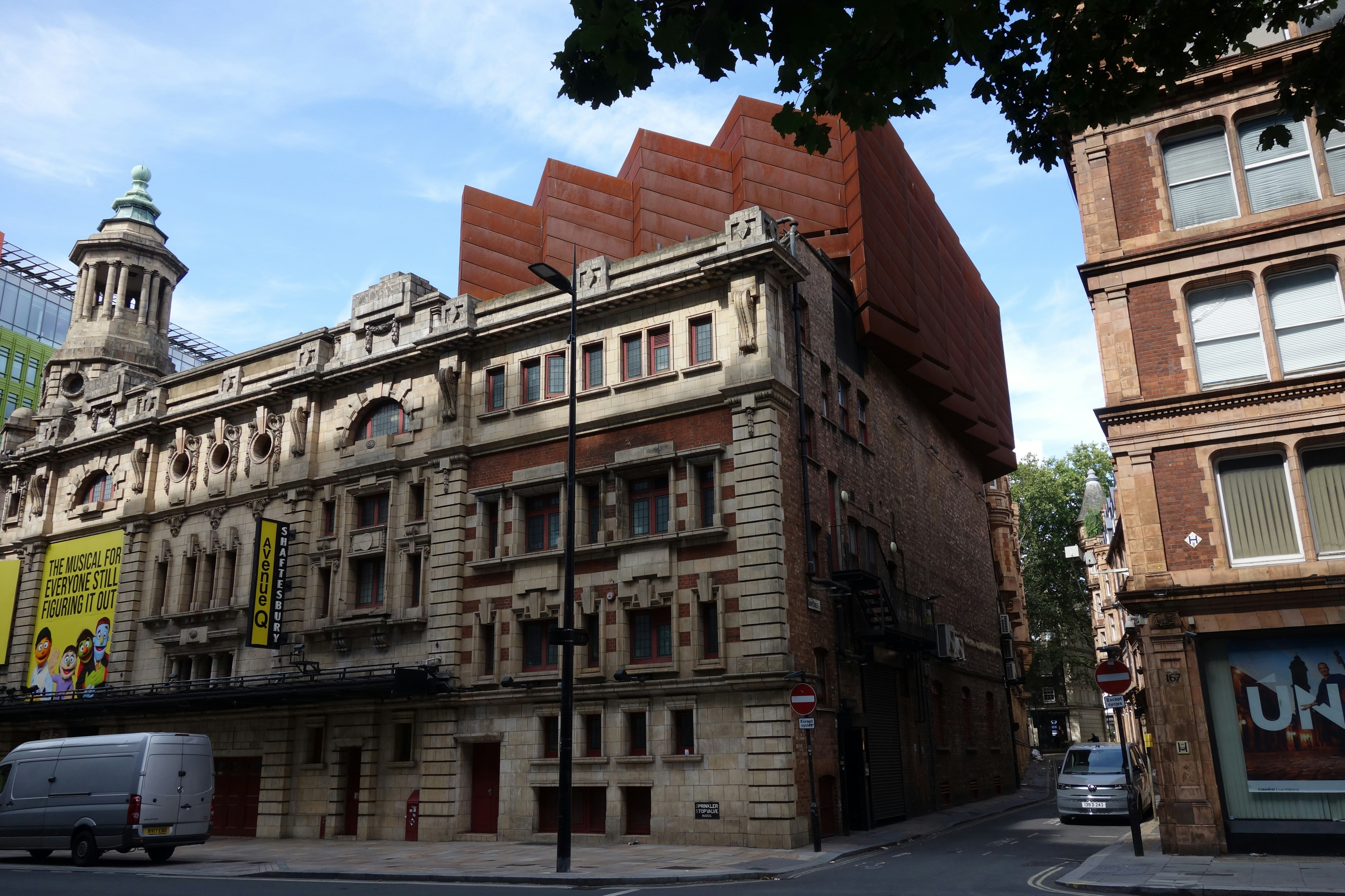 Gothic Brick meets Modern Red Facade: A City Corner With Contrasting Architectures