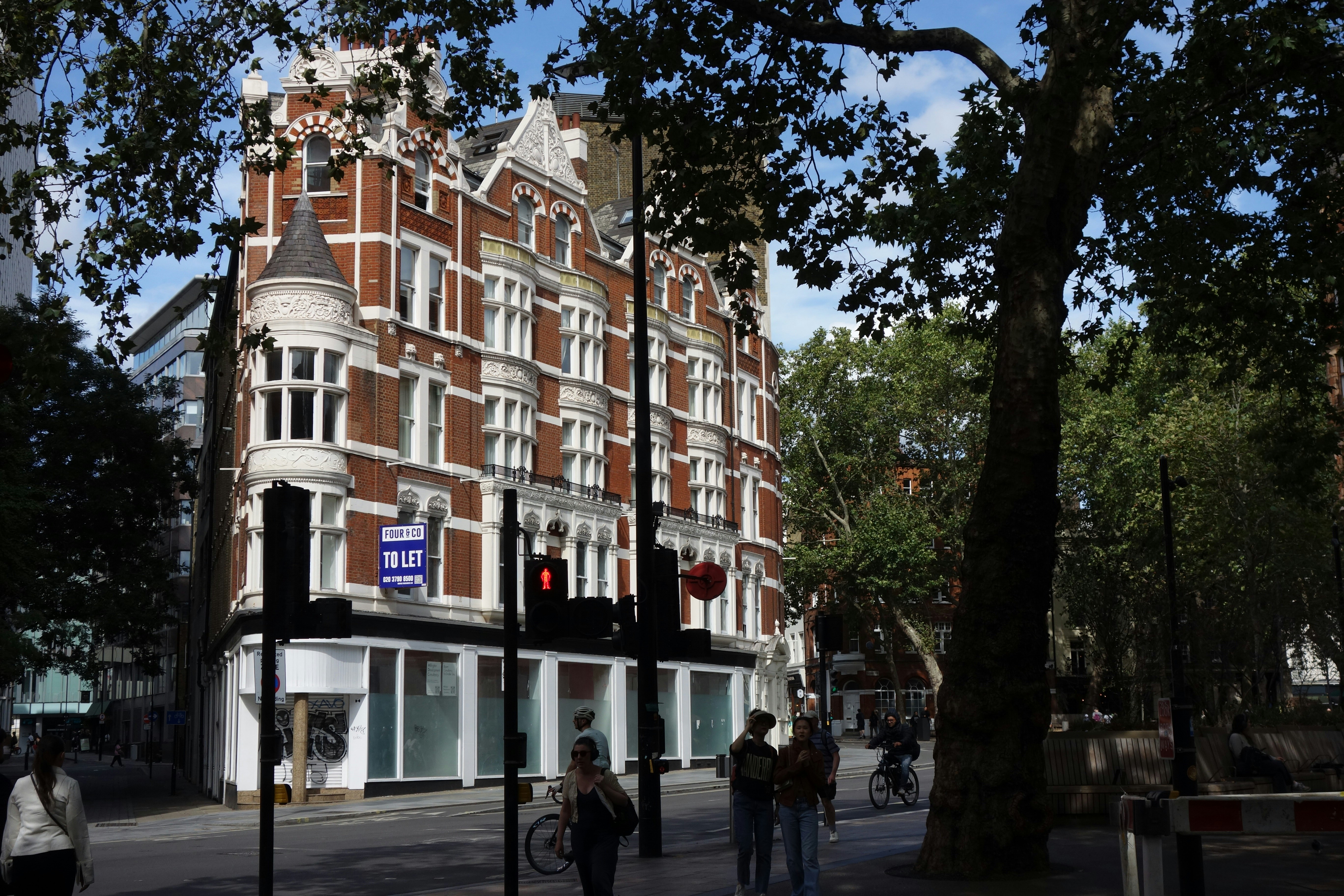 Heritage Corner: Red Brick Architecture on a Bustling City Street