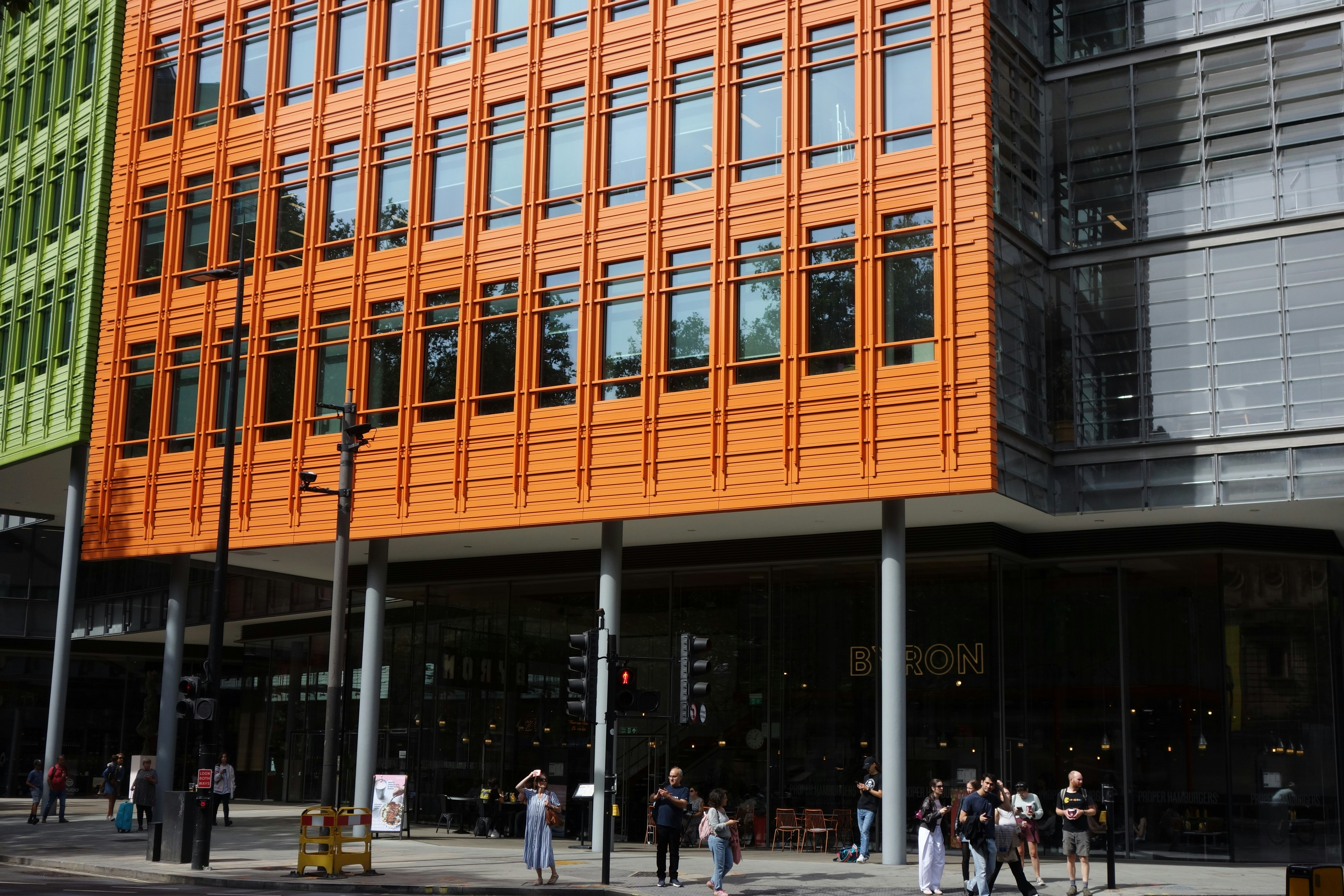 Orange facades and glass registrar: a city block of modern office frontage