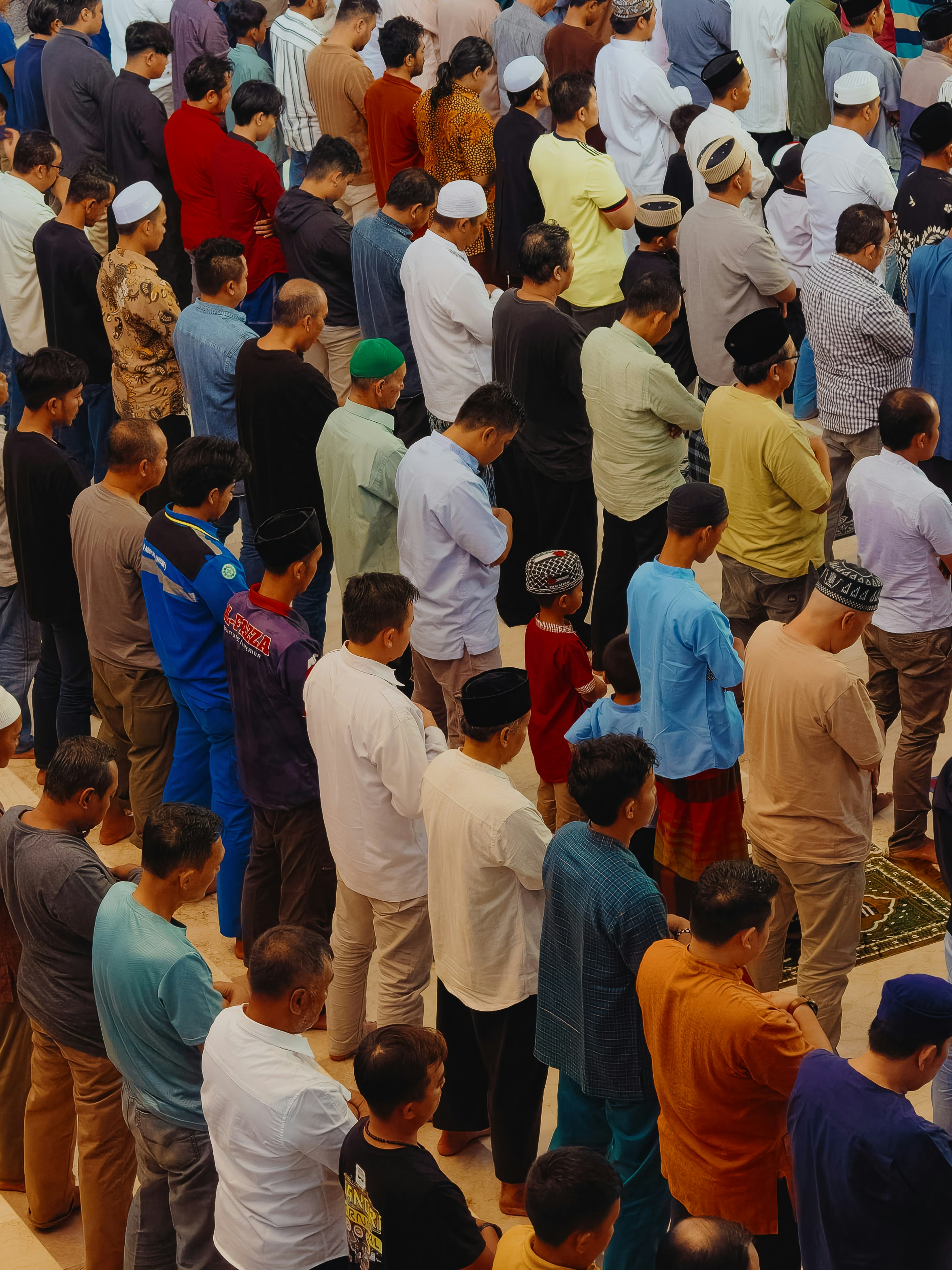 In Quiet Lines: A Prayerful Congregation Amid Multicolored Attire