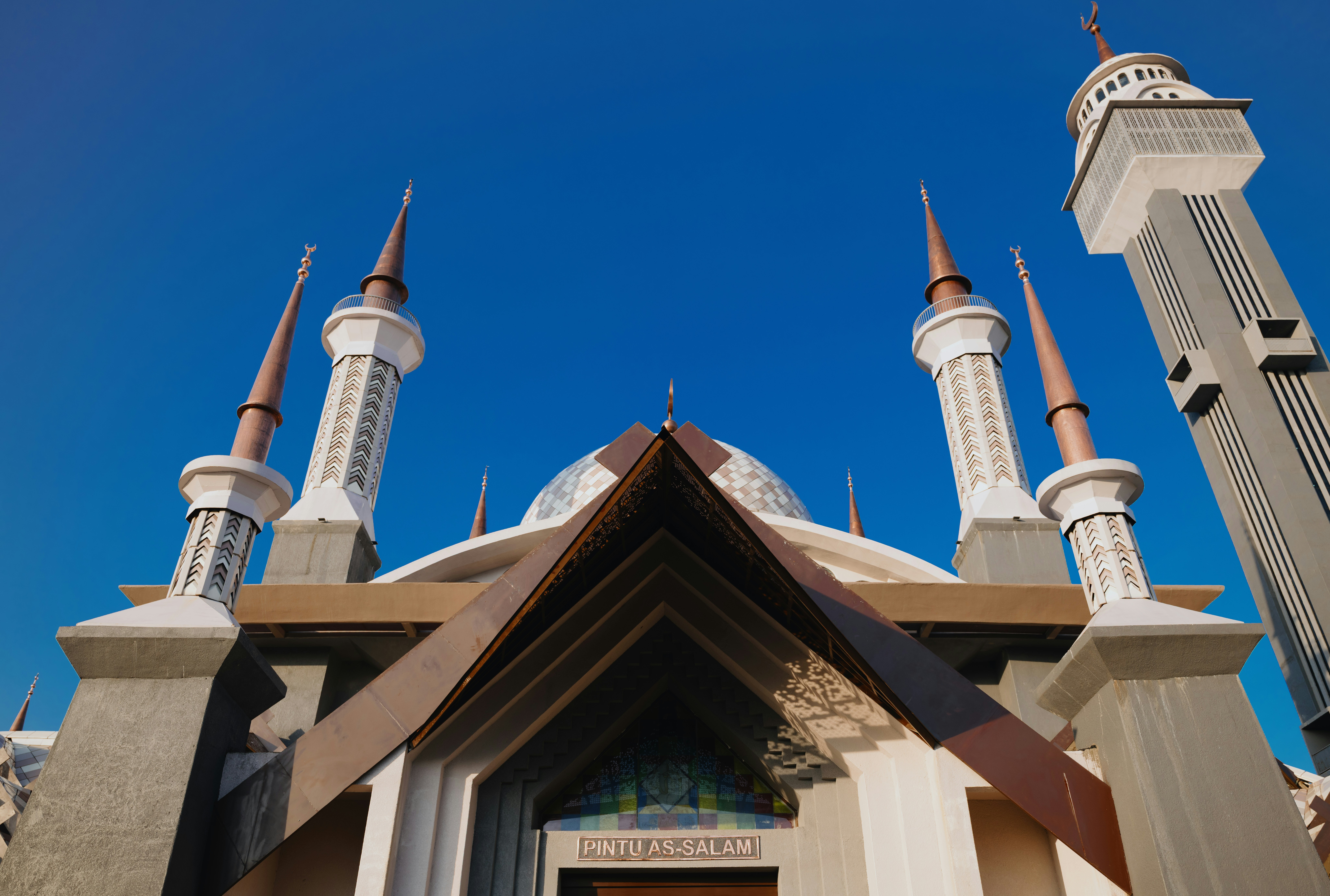 Temple Spire and Domed Roof: Symmetry Under a Clear Sky