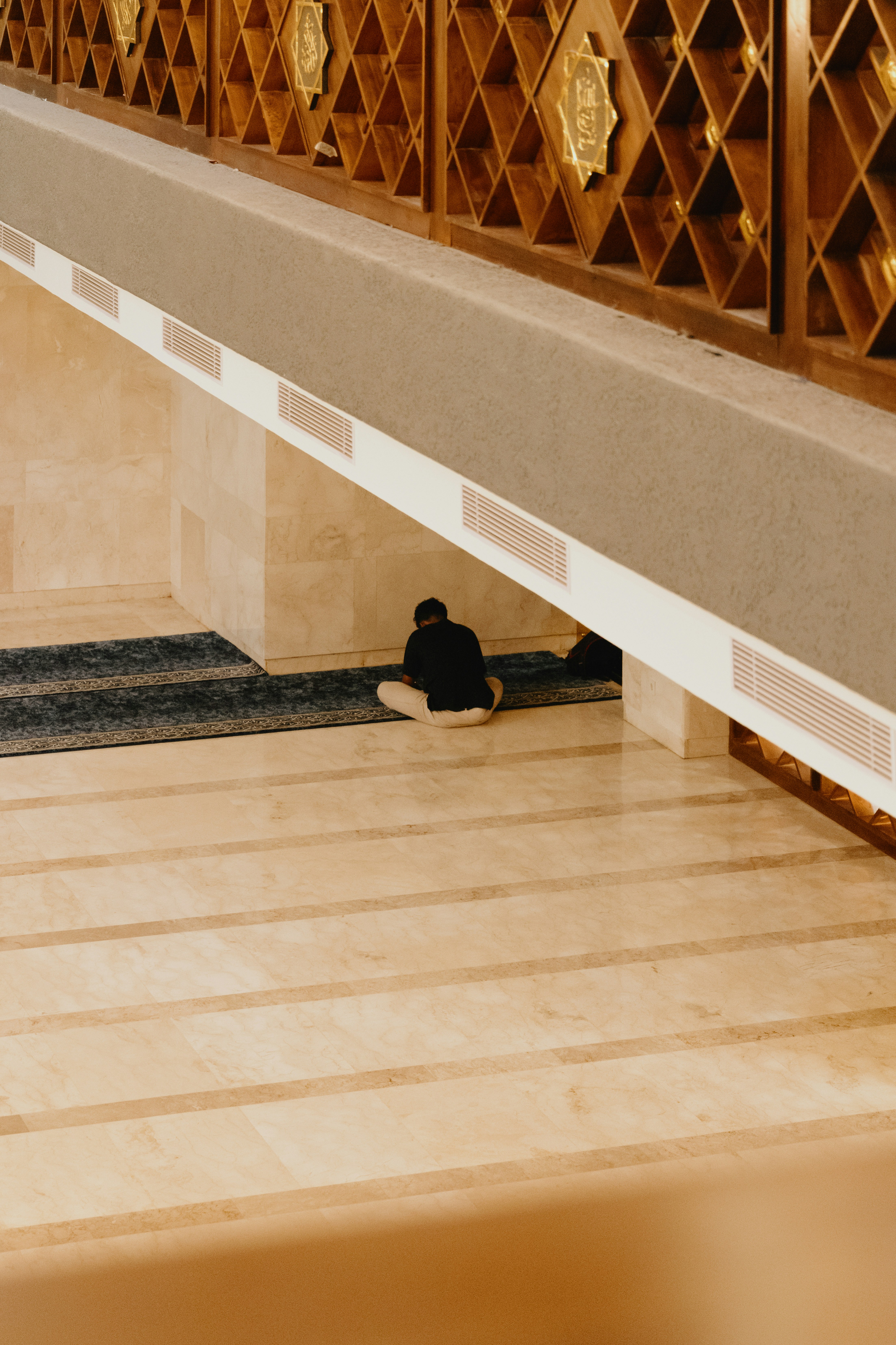Silent Figure Under the Arch: A lone visitor in a marble corridor