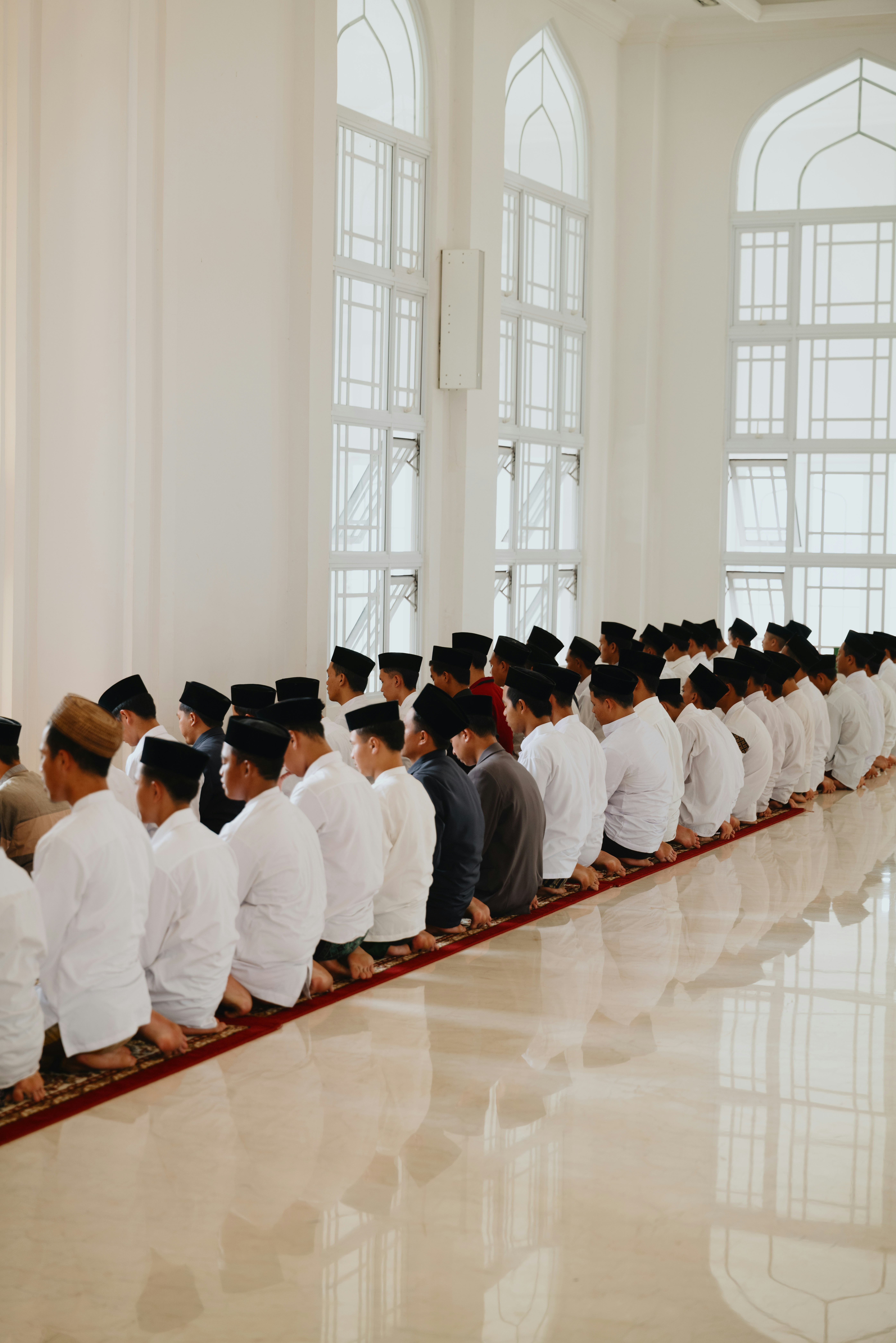 Row of Worshippers in a Sunlit Hall