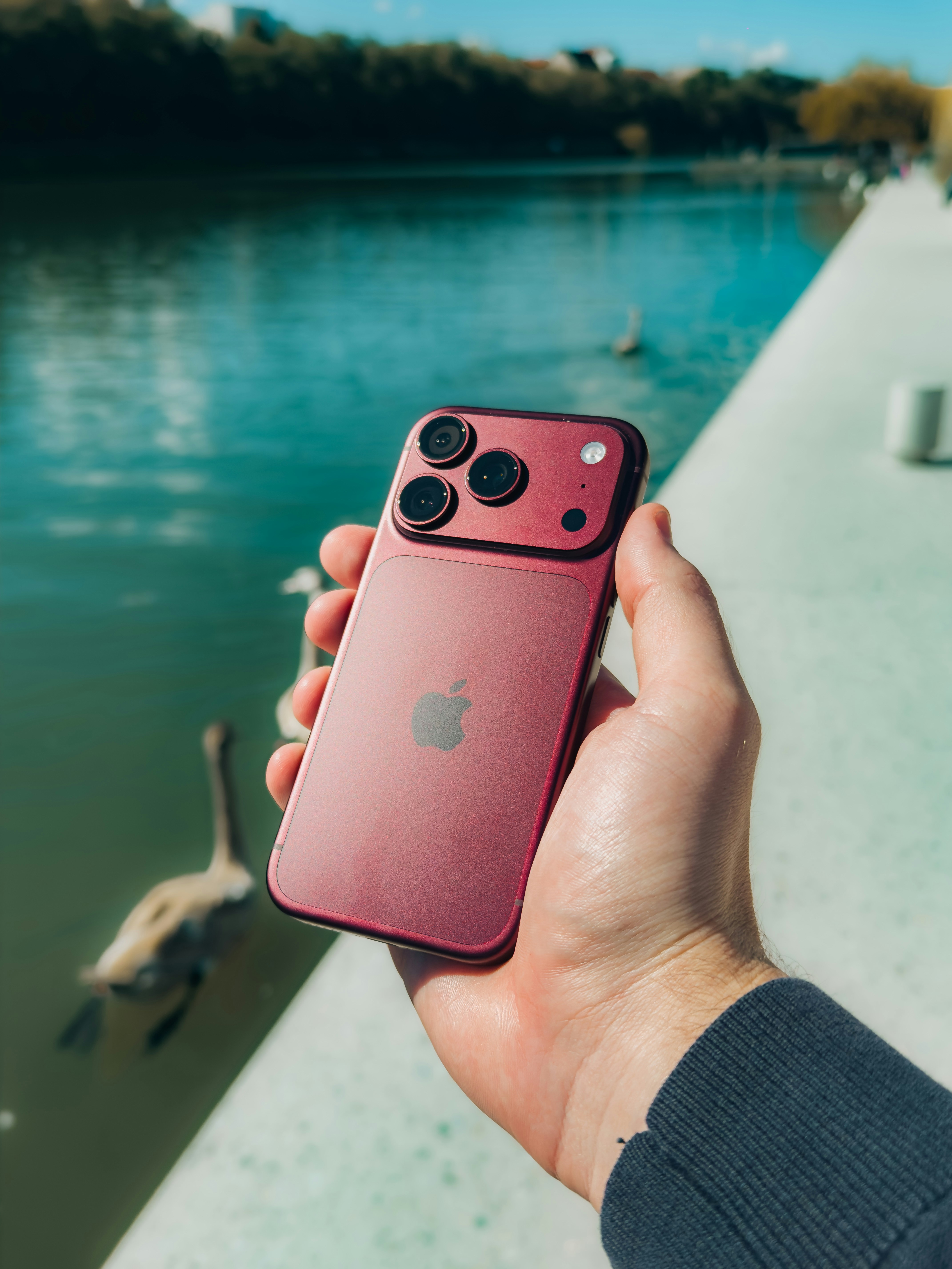 Rose-tinted Pro: A hand-held iPhone by the riverside