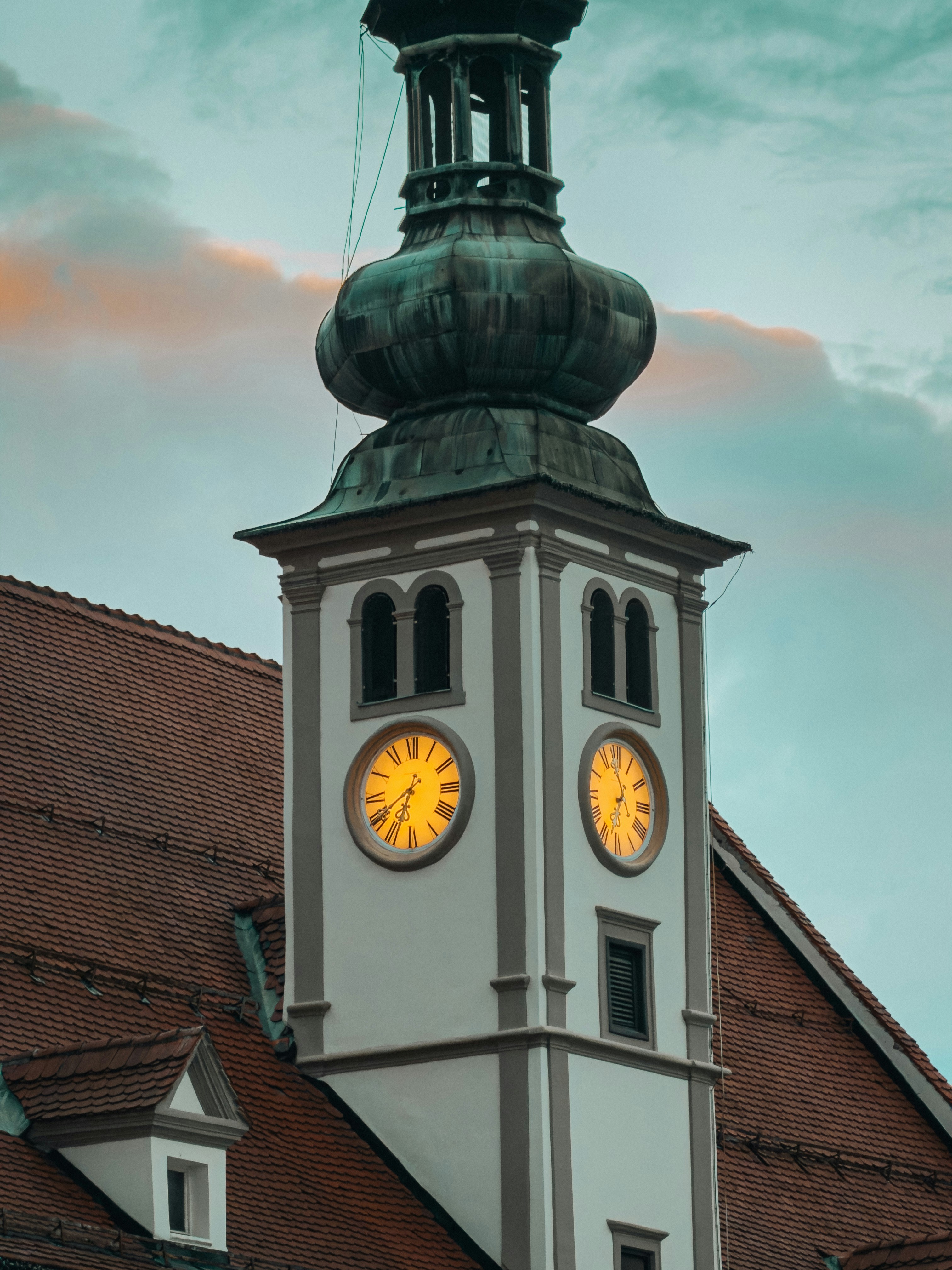 Clocktower in Warm Sunset: A European Rooftop Serenade