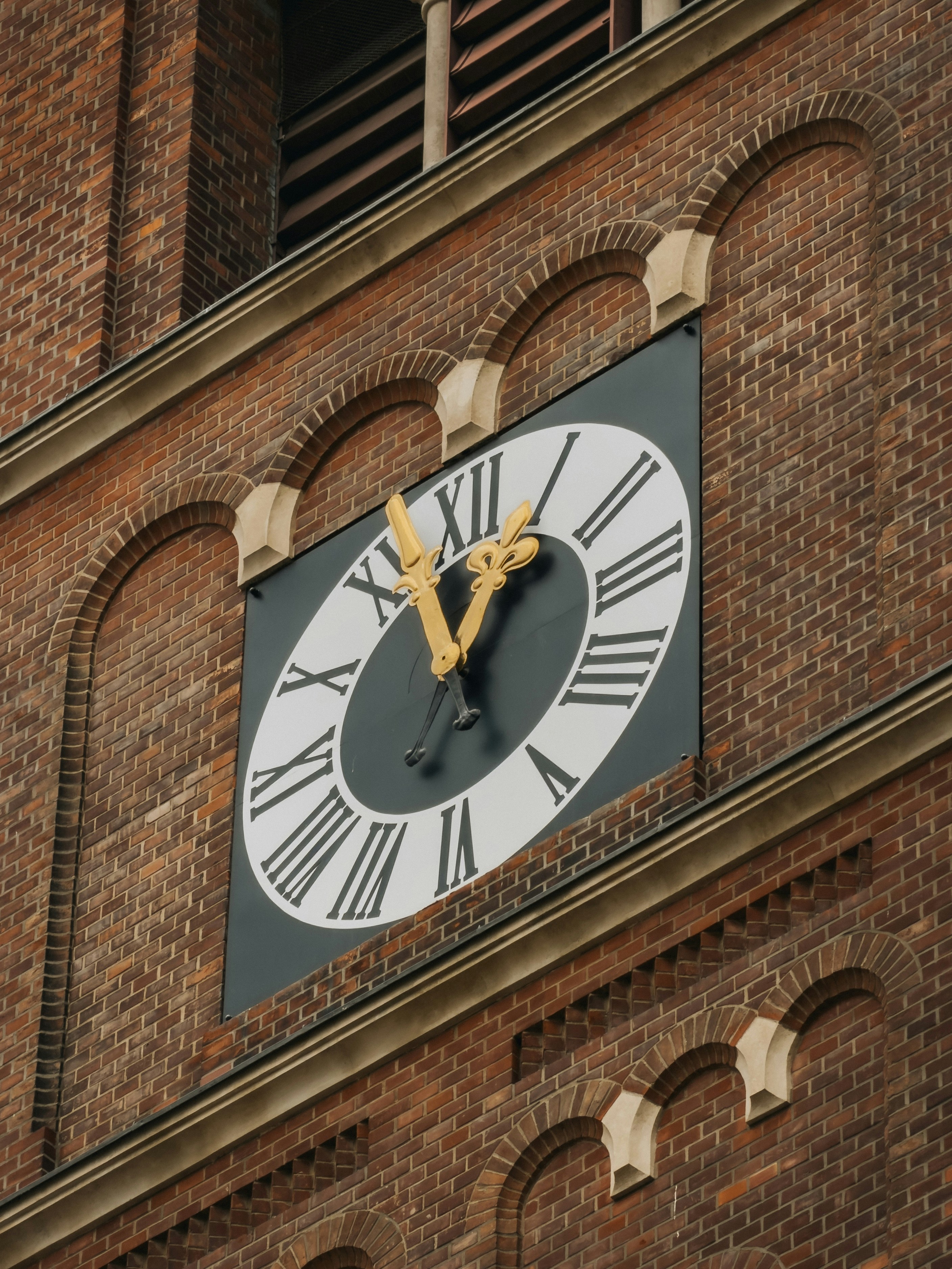 Clock Tower Gaze: Golden Hands on a Brick Facade
