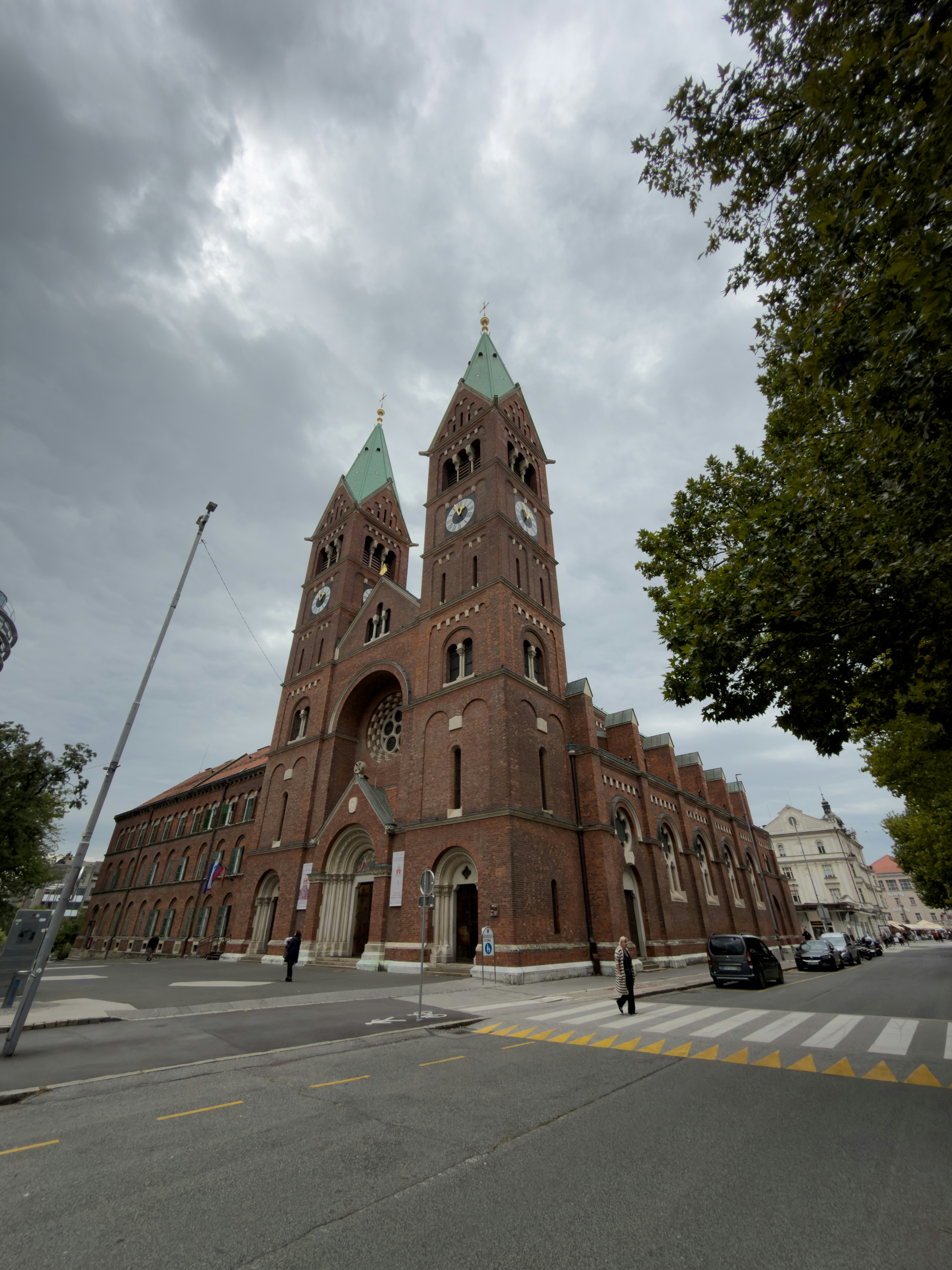 Twin-Towered Brick Cathedral Reaching Toward a Stormy Sky