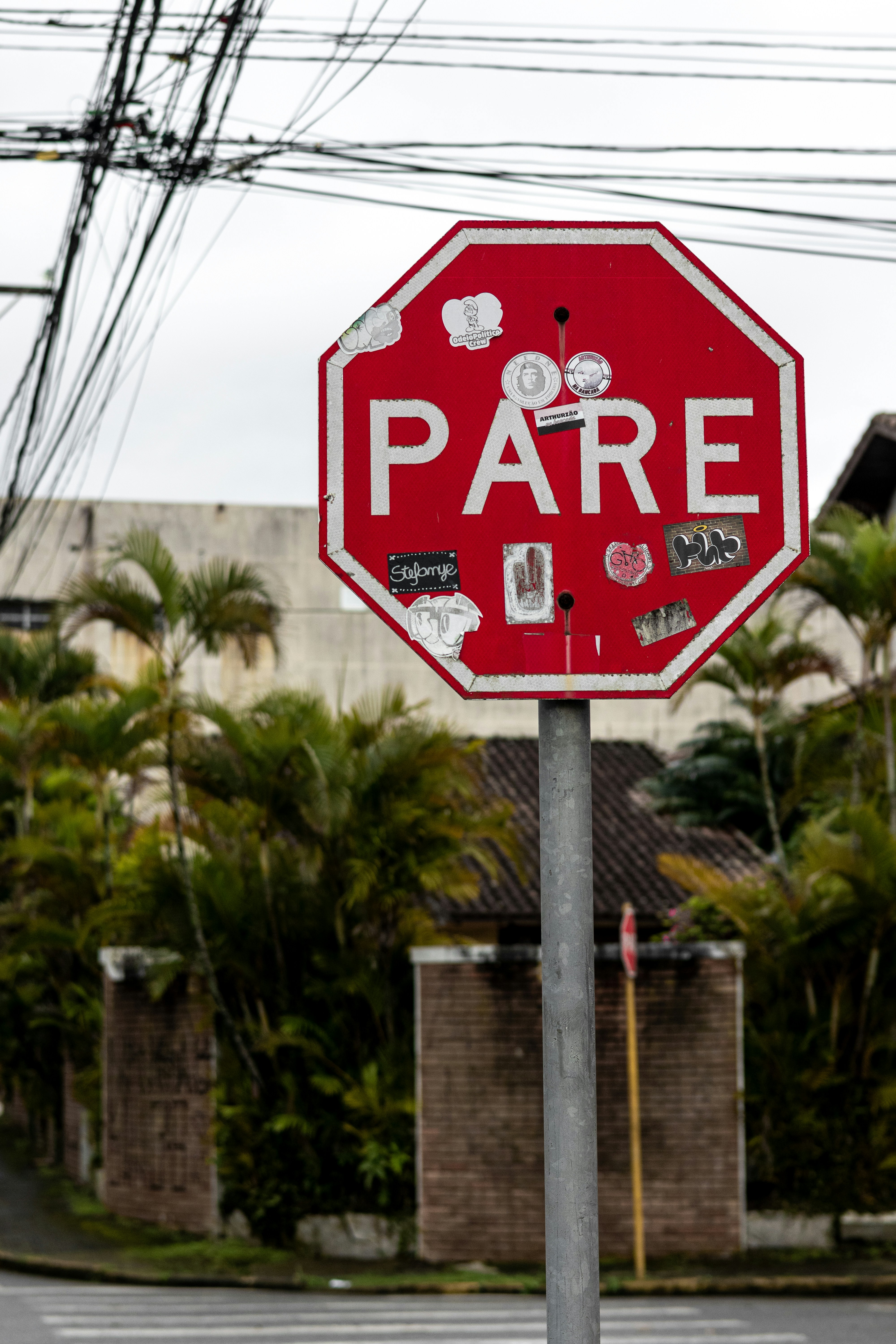 Stickered Stop Sign Dominating a Quiet Street
