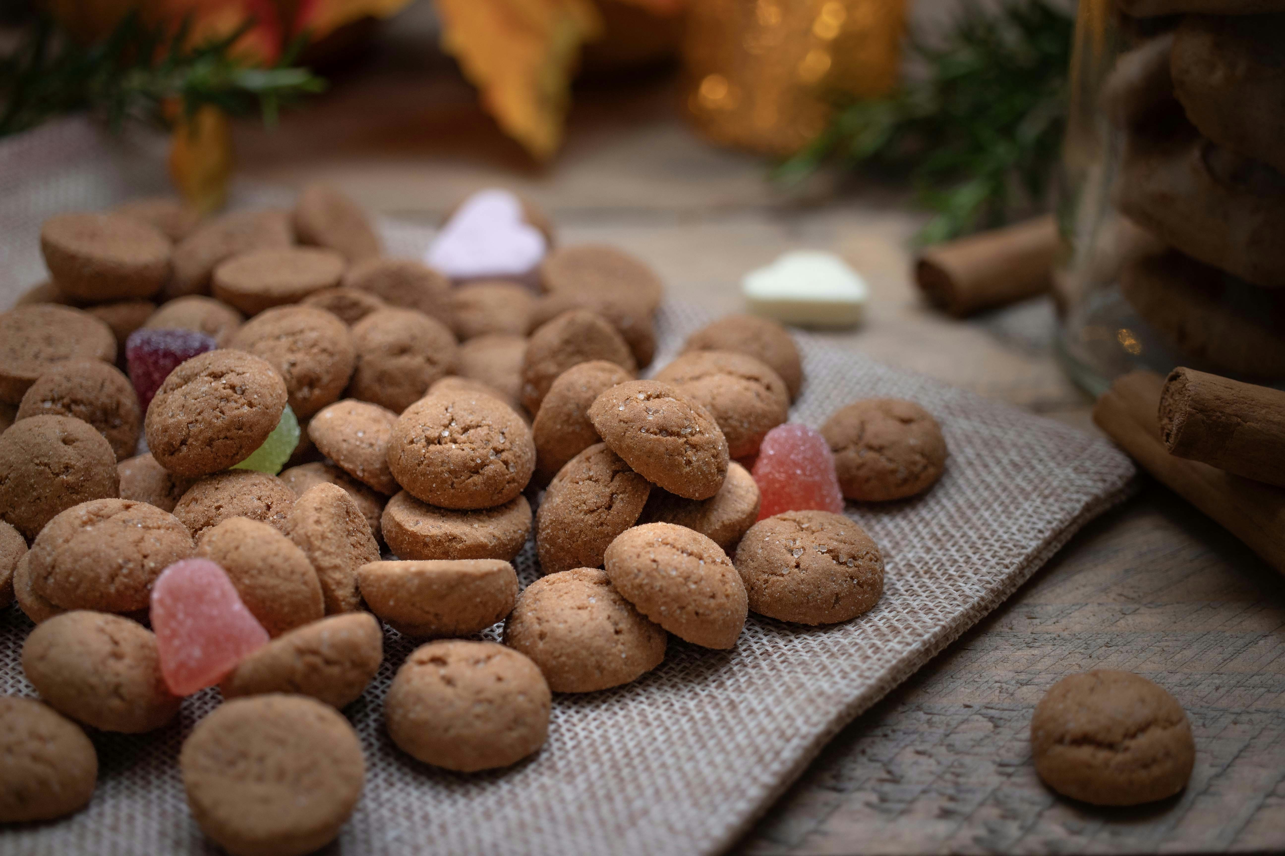 Cozy platter of cocoa cookies and pastel gummies on a rustic linen mat