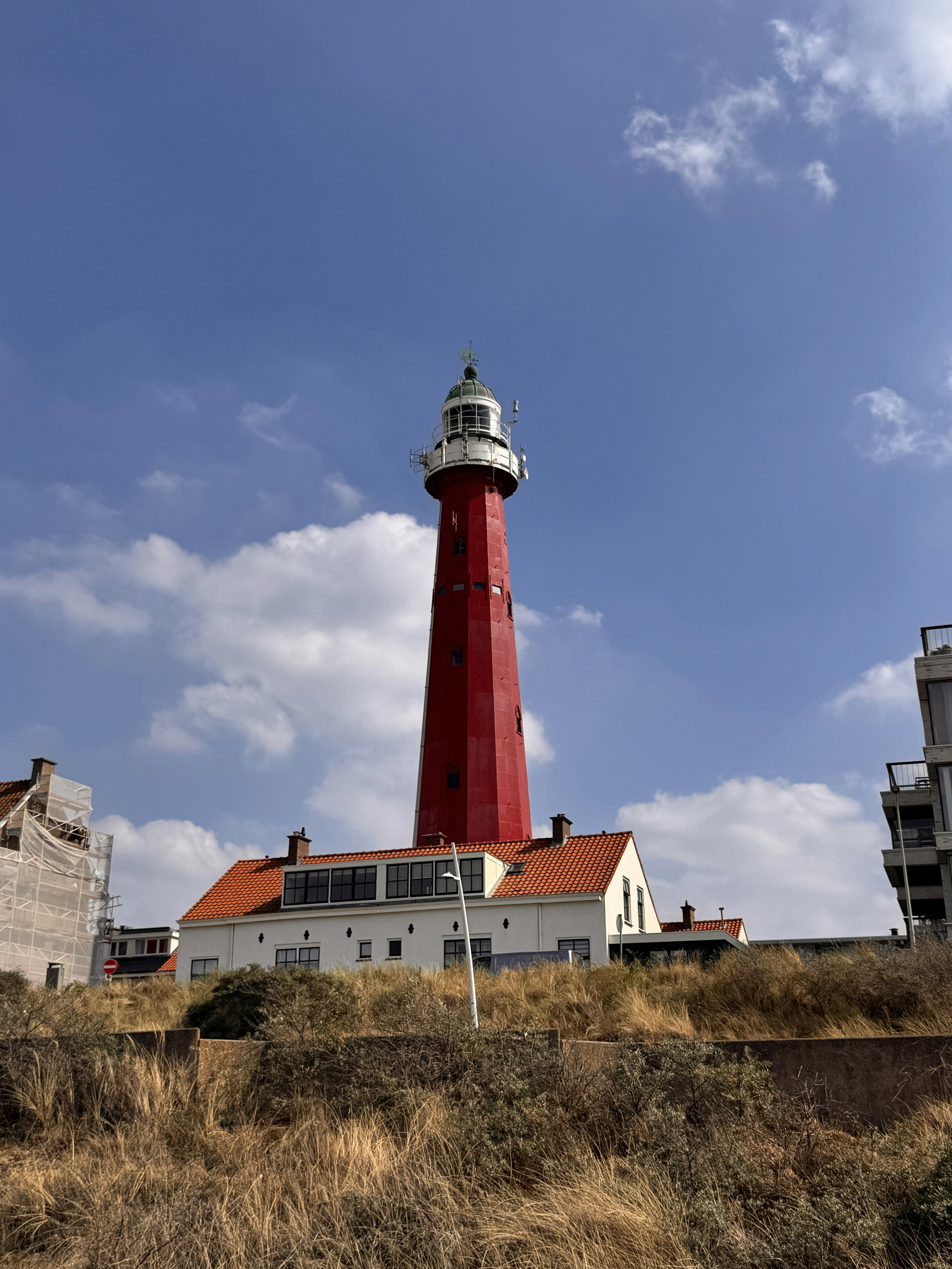 Red Beacon on the Coast: A Lone Lighthouse Reaching Toward the Sky
