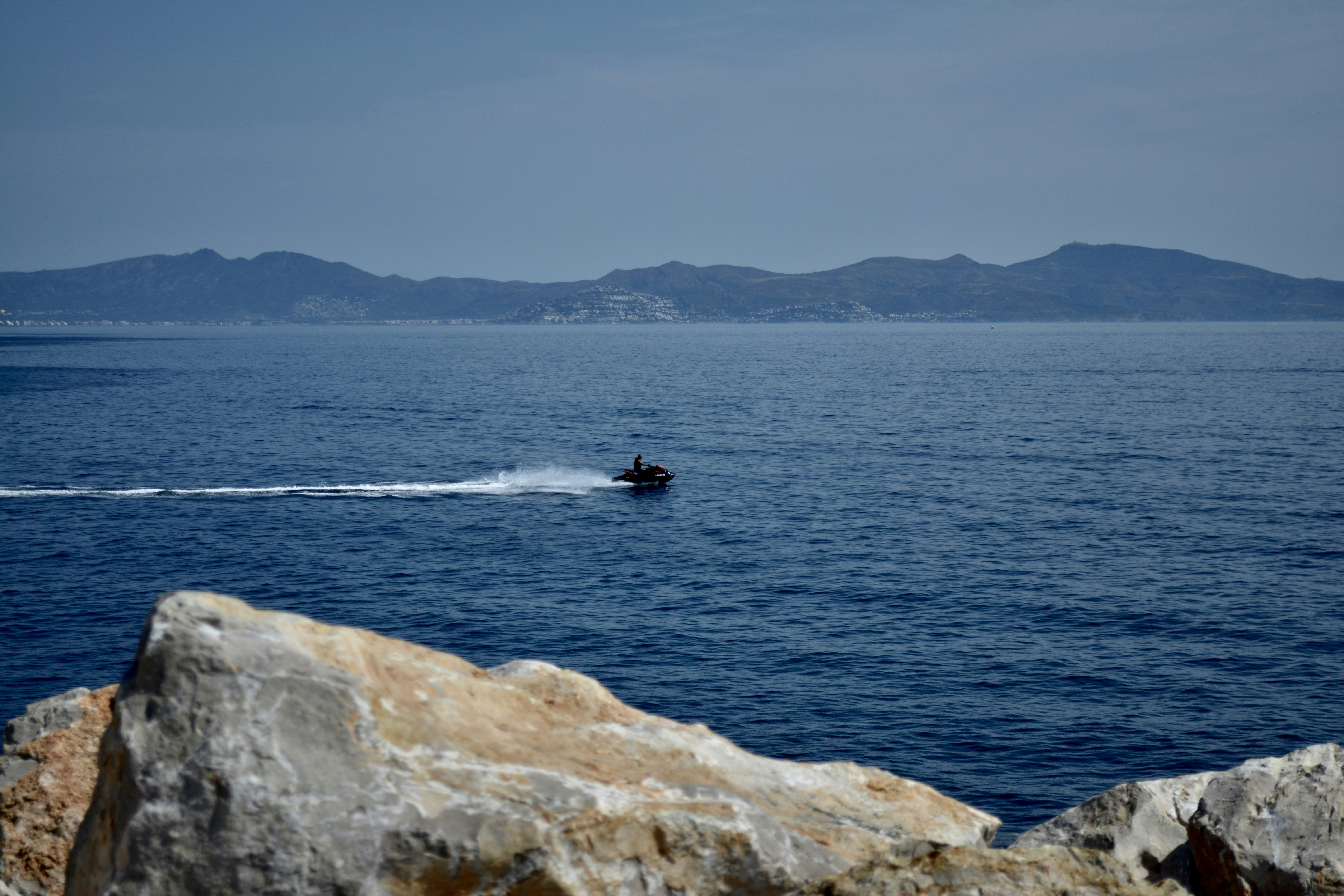Jet Skim Across a Quiet Blue Horizon