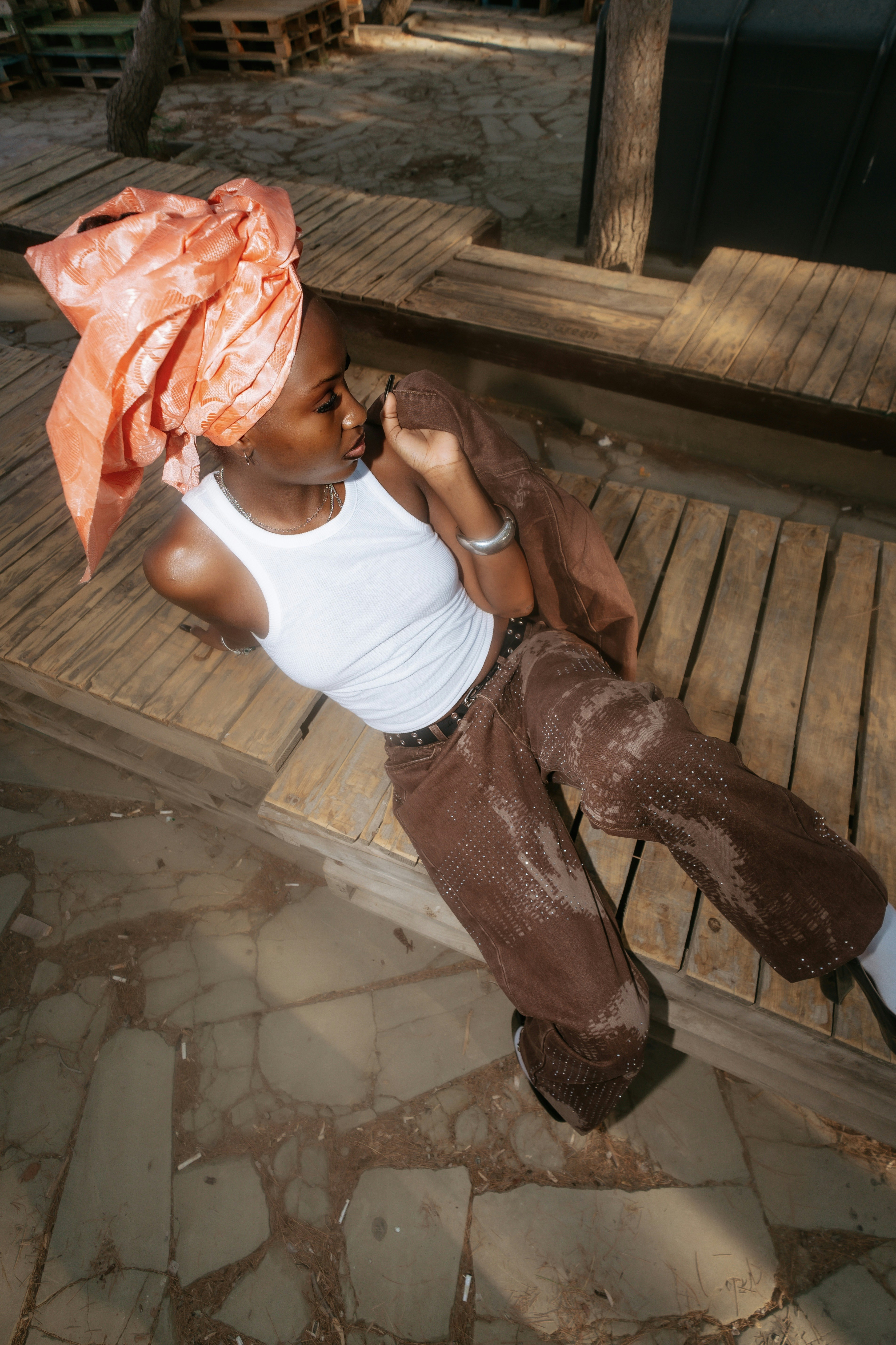 Portrait in a Rustic Swing: Portrait of Confidence under a Coral Headwrap