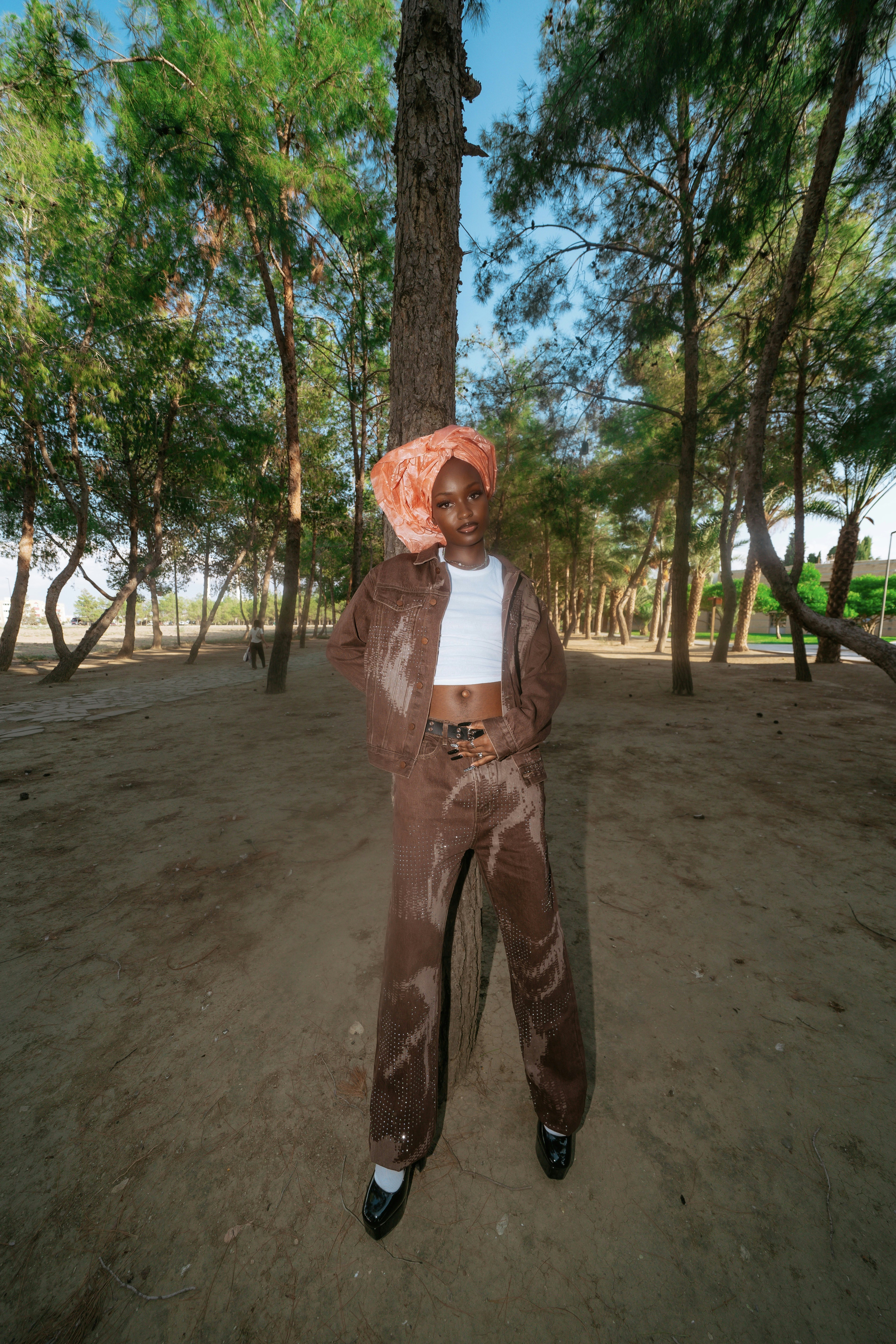 Bold Pose Under Cedar Canopy in Brown Sequins