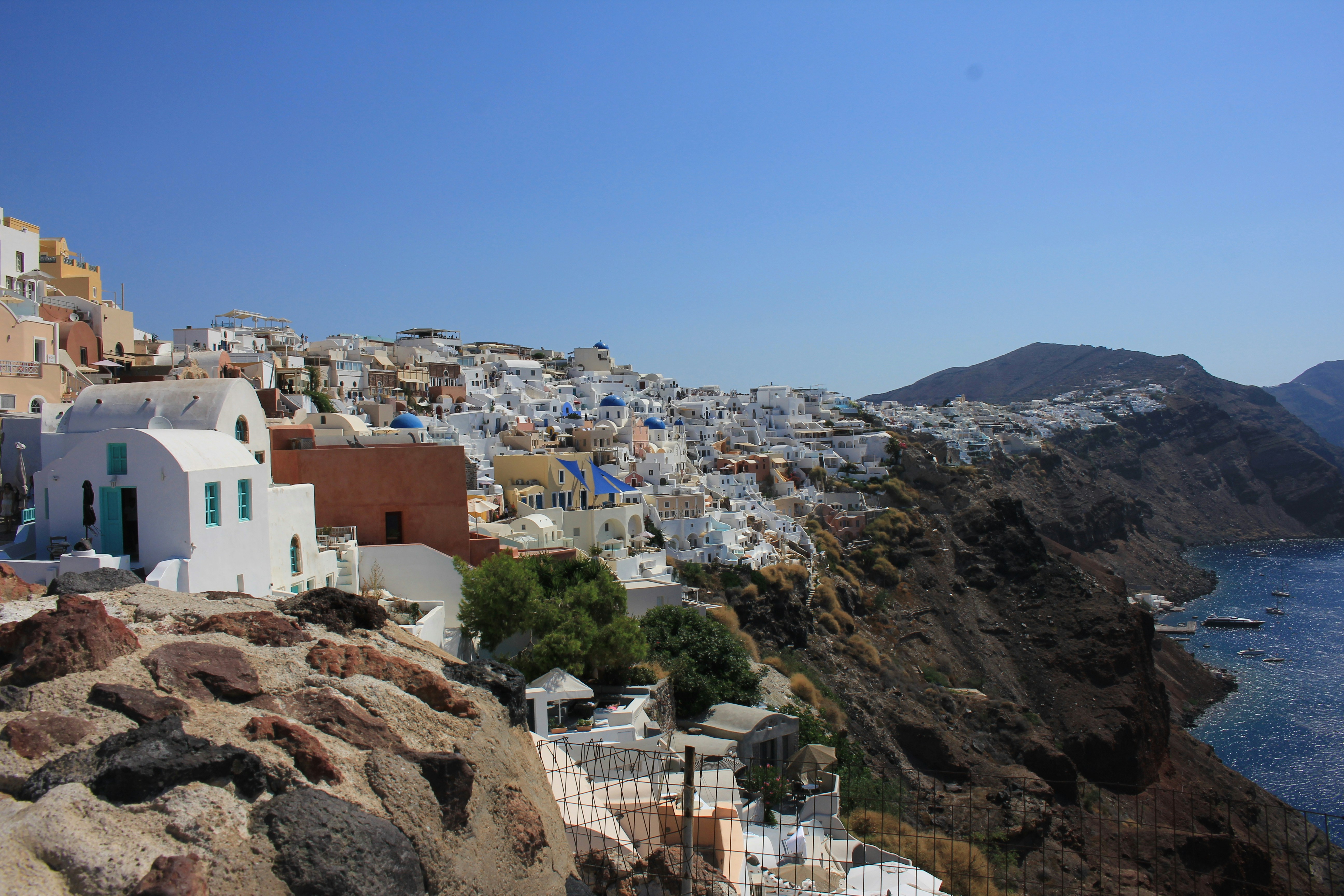 White-washed village on a sunlit Cycladic cliffside