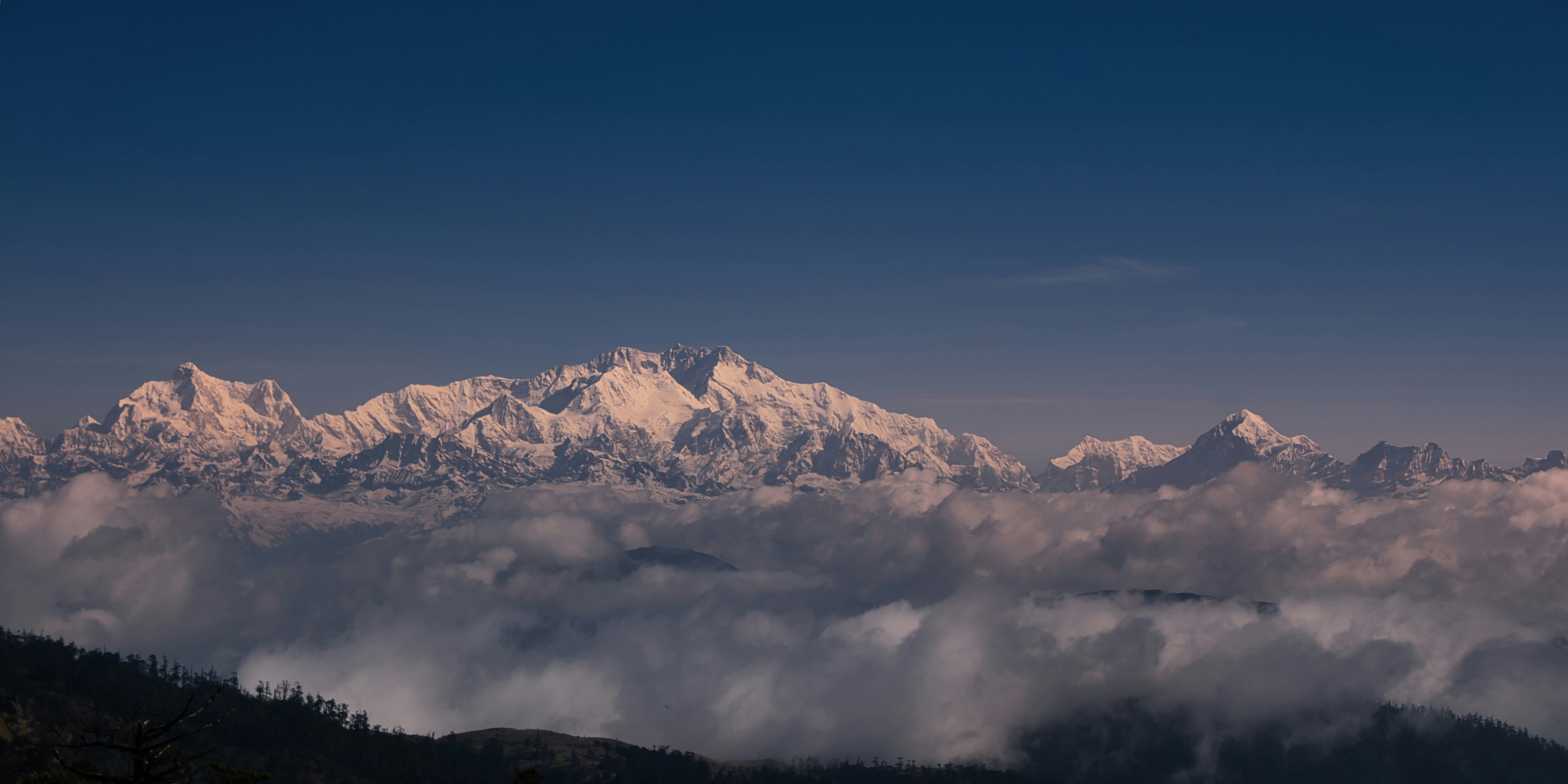Snow-Crowned Ridge Above a Sea of Clouds