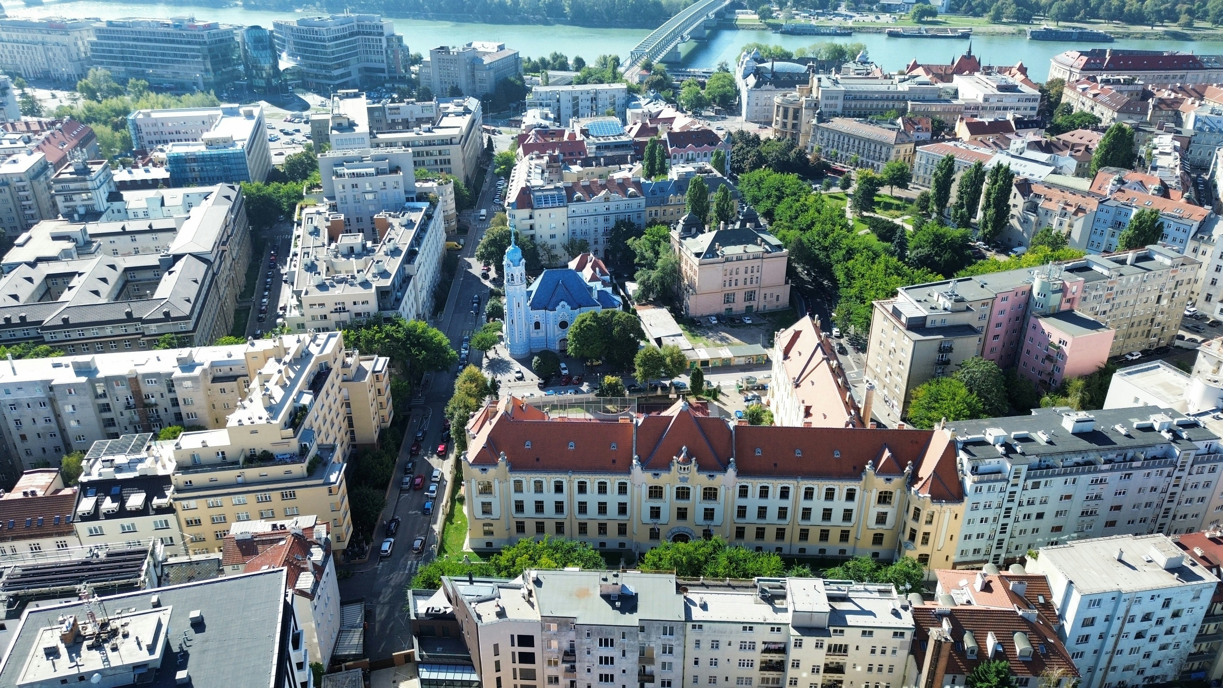 Aerial mosaic: sunlit rooftops and verdant courtyards knit a European city