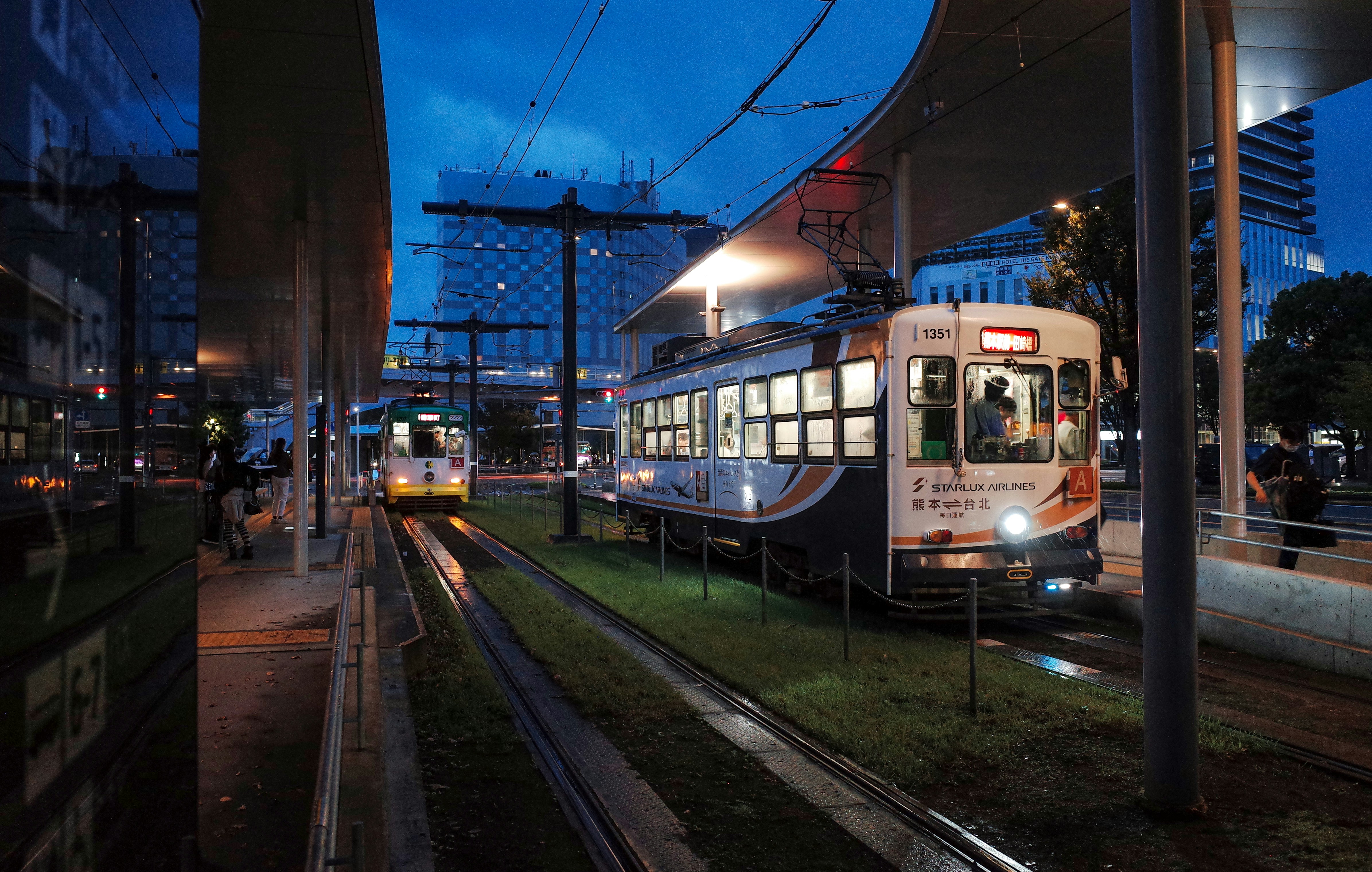 Urban Tram at Dusk: Rails, Reflections, and Neon