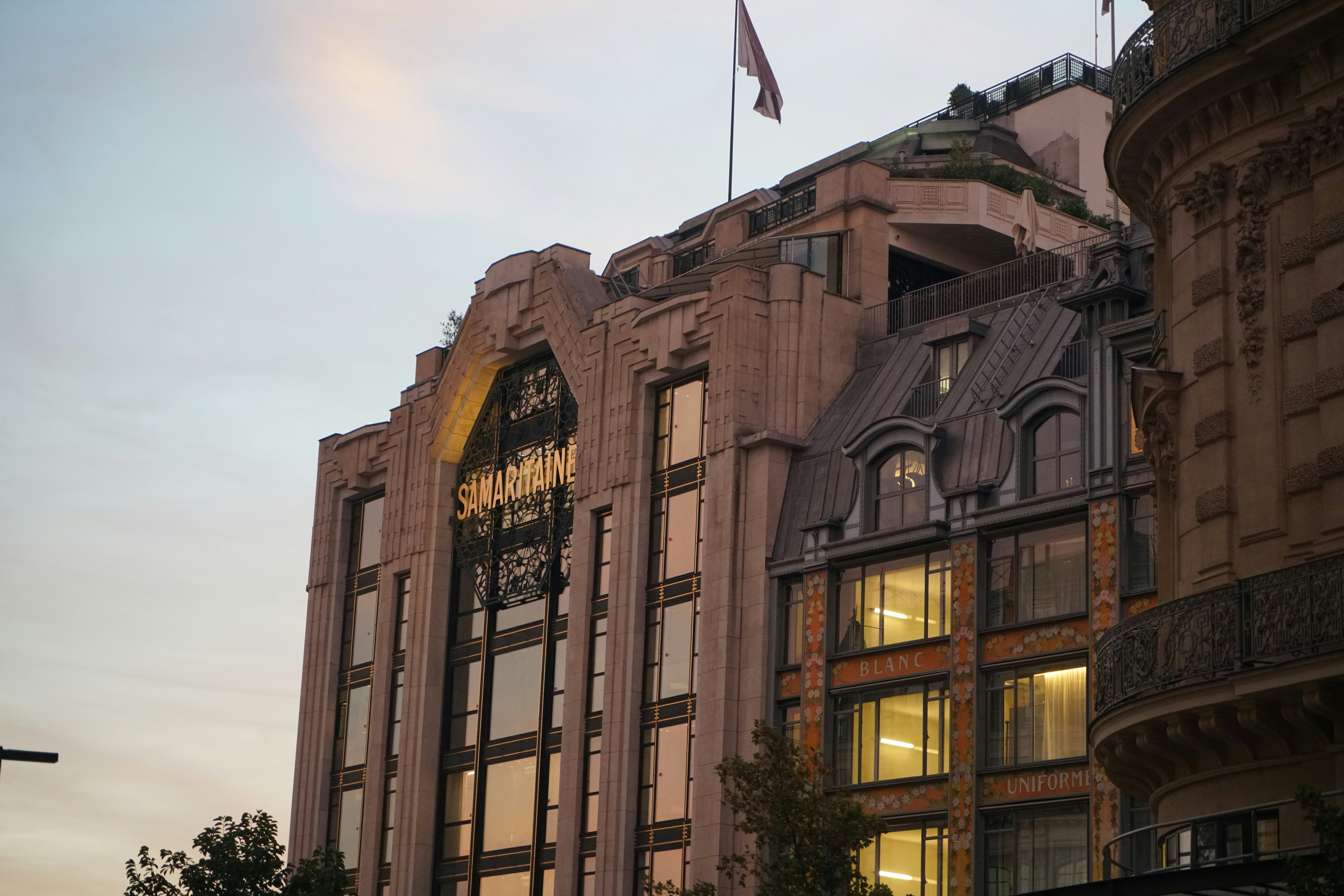 Historic Corner: Illuminated Facade and Flag Above the City