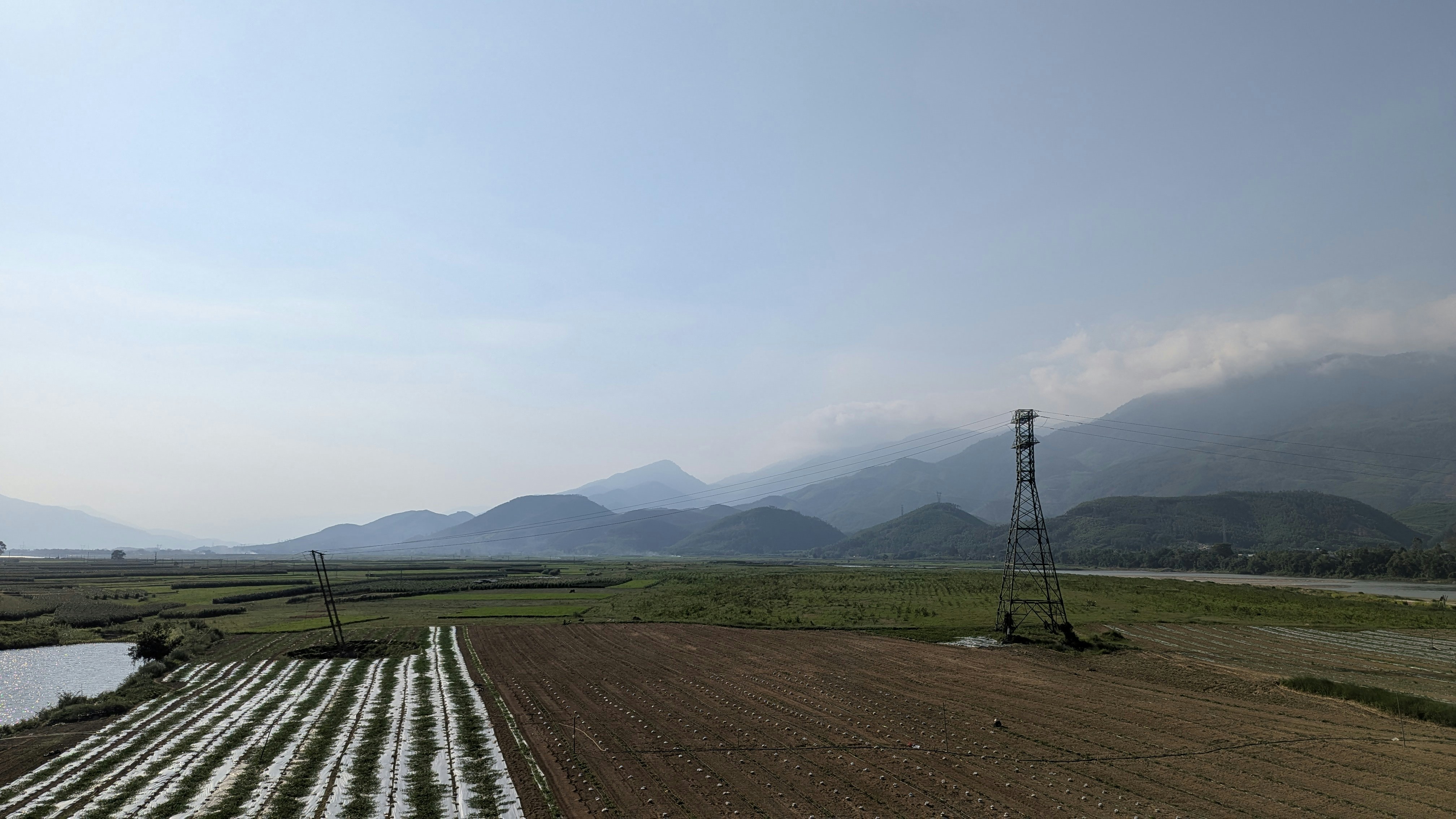 Farmland Echoes: Skyward Mountains and Field Rows