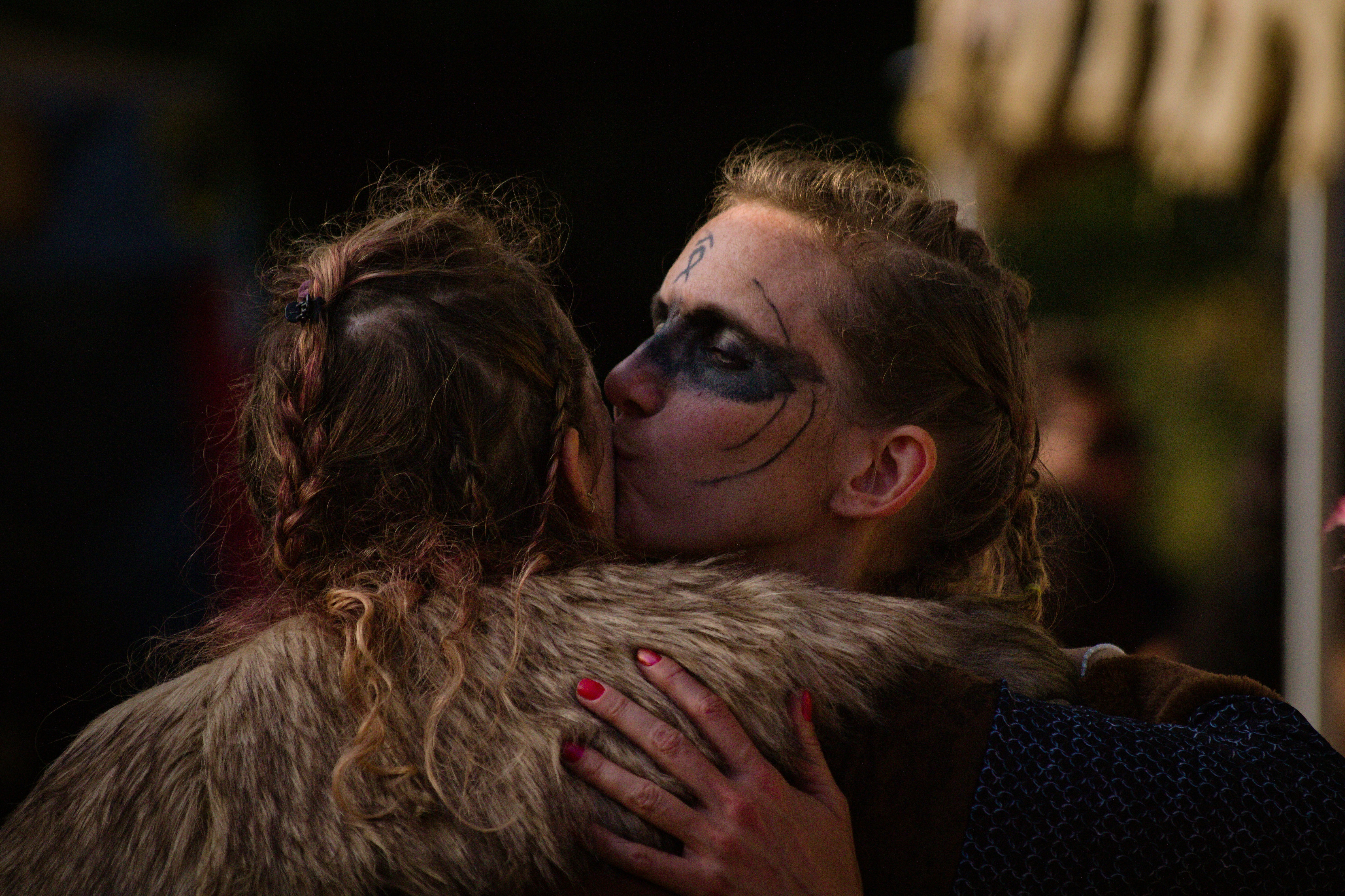 Midnight Embrace: Face Paint and Fur in a Quiet Kiss