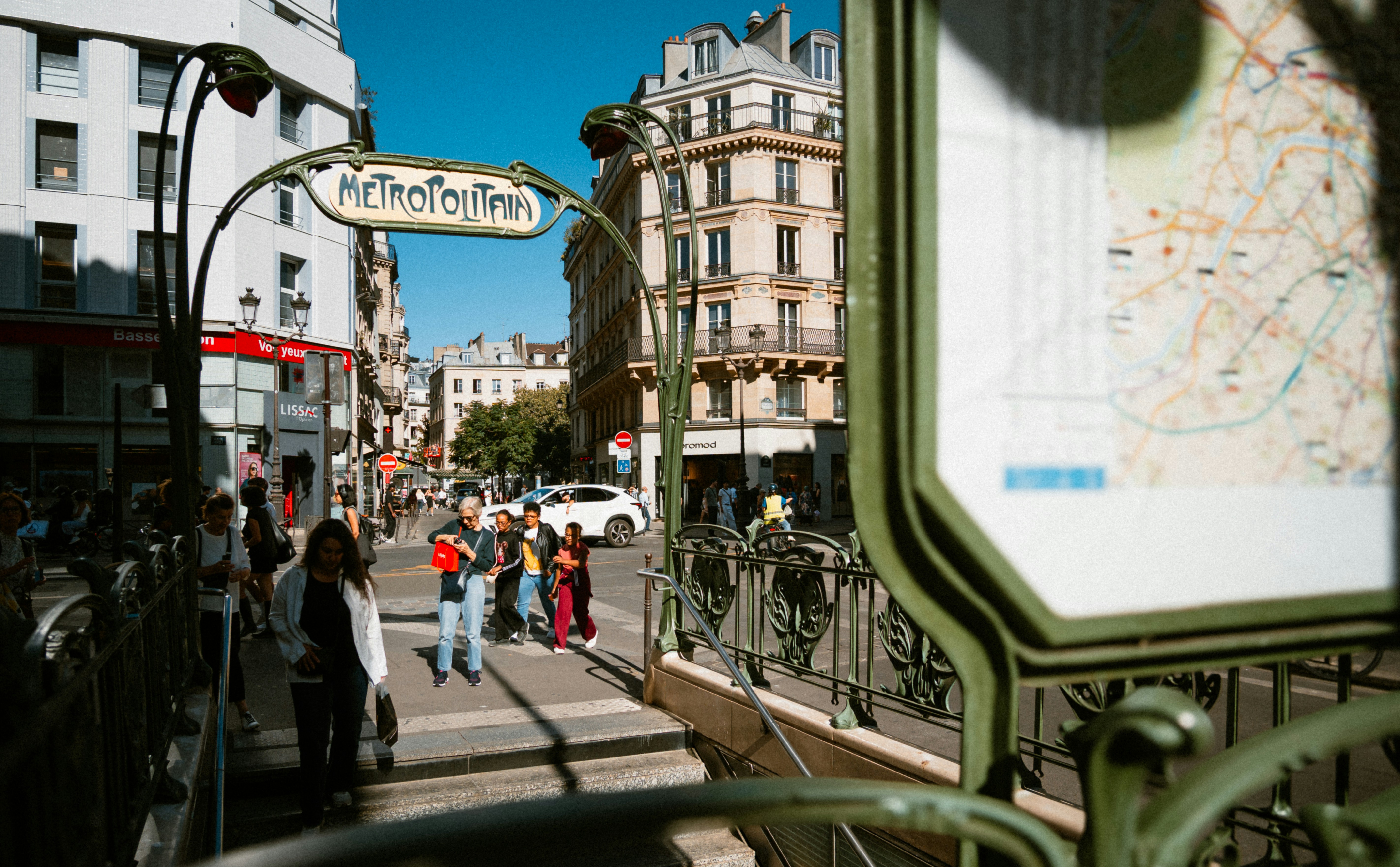 Metro Sign Reflections: A Parisian Street Scene by the Metal Arch