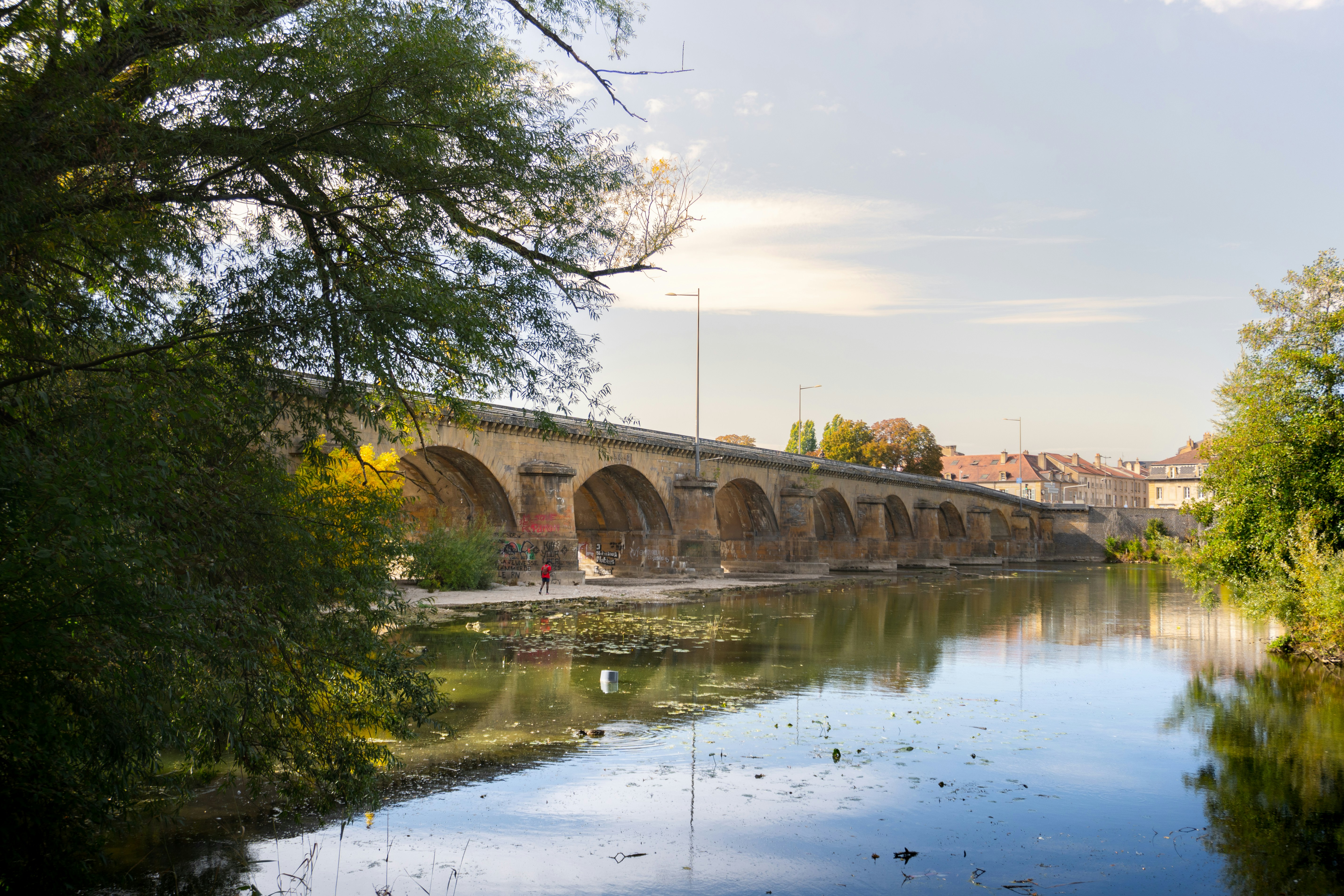 Stone Bridge Over Quiet Waters: A Riverside Corridor