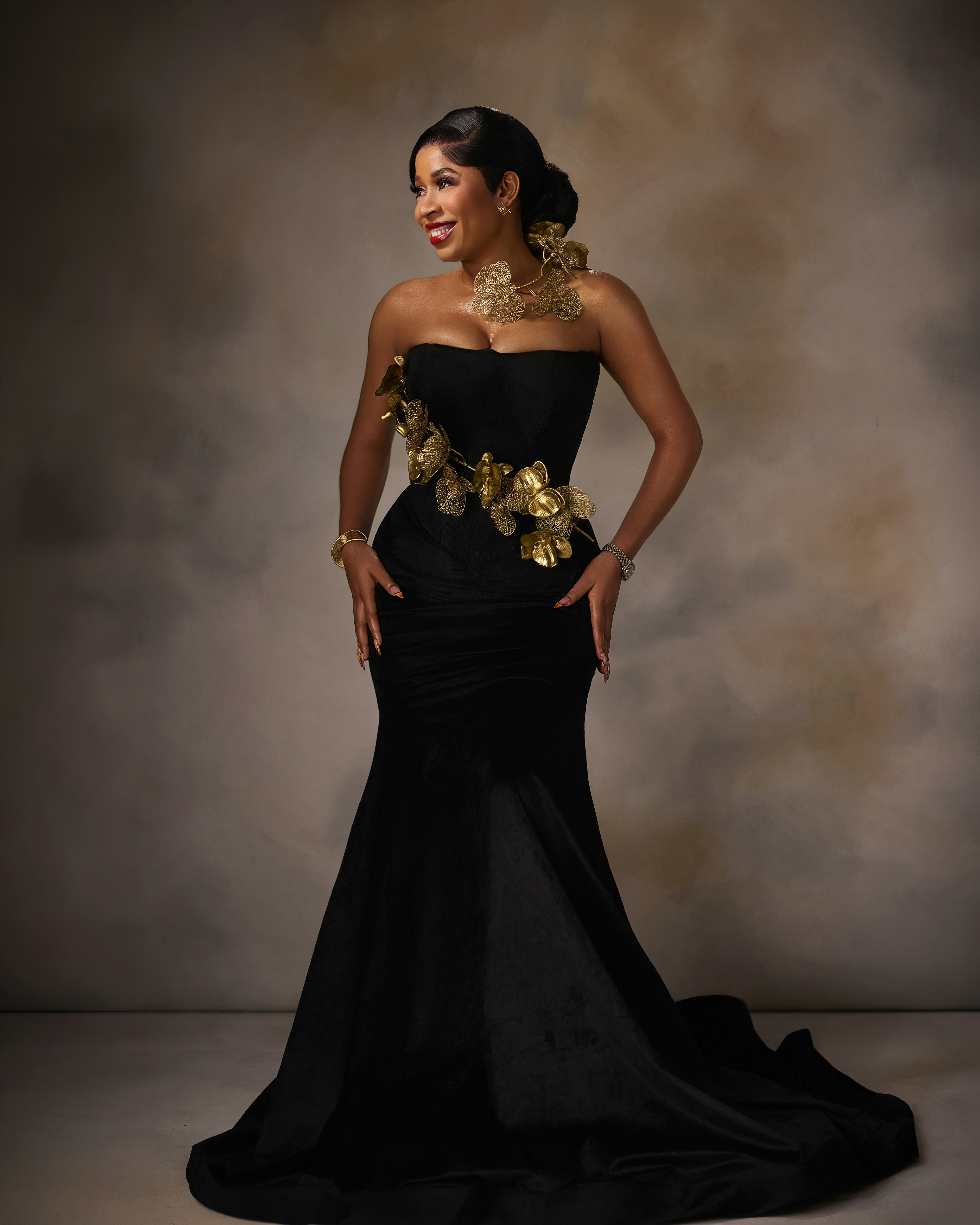 Elegant Black Gown Bloom: A Confident Red-Carpet Pose
