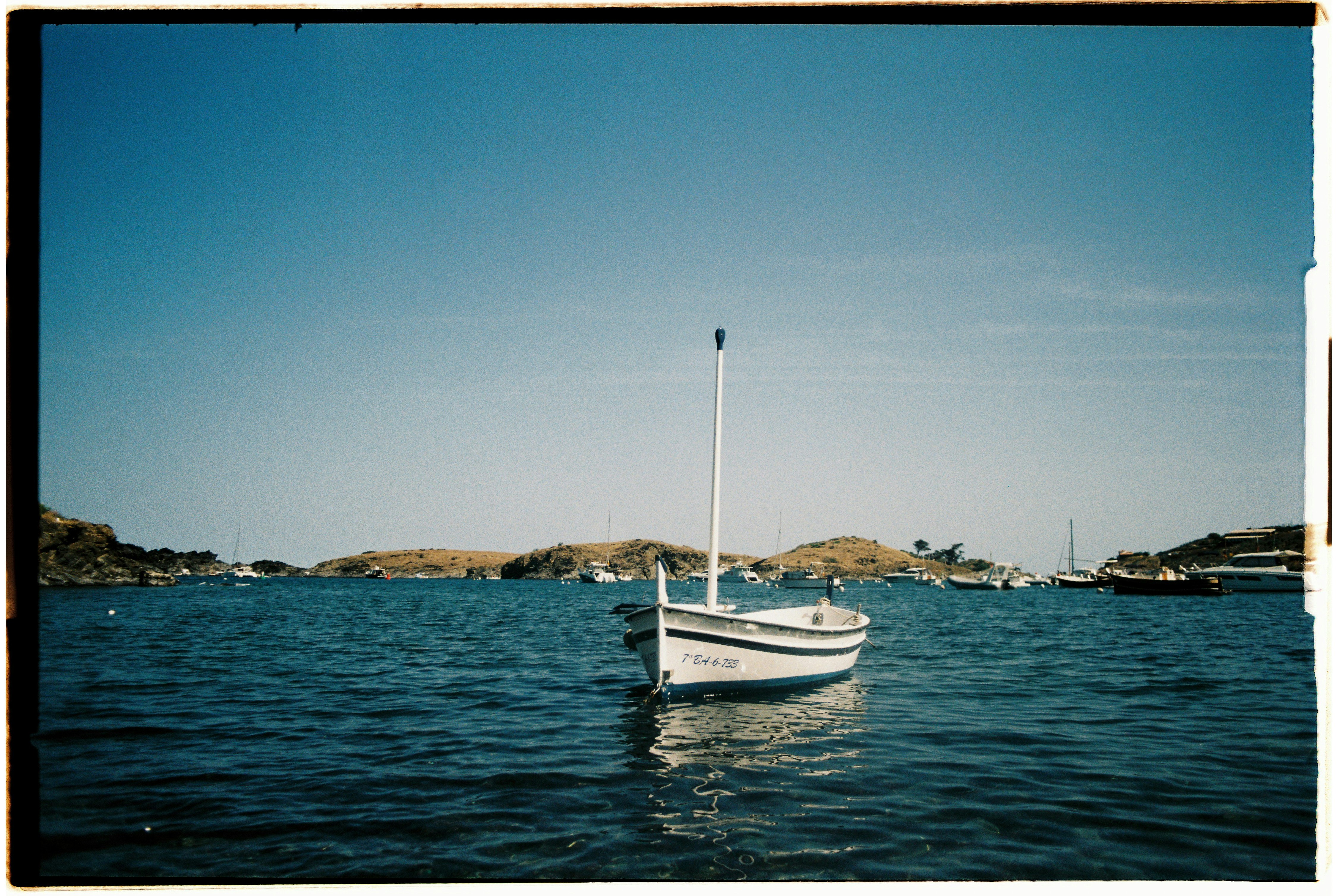 Solitary Boat Centered on Quiet Blue Waters