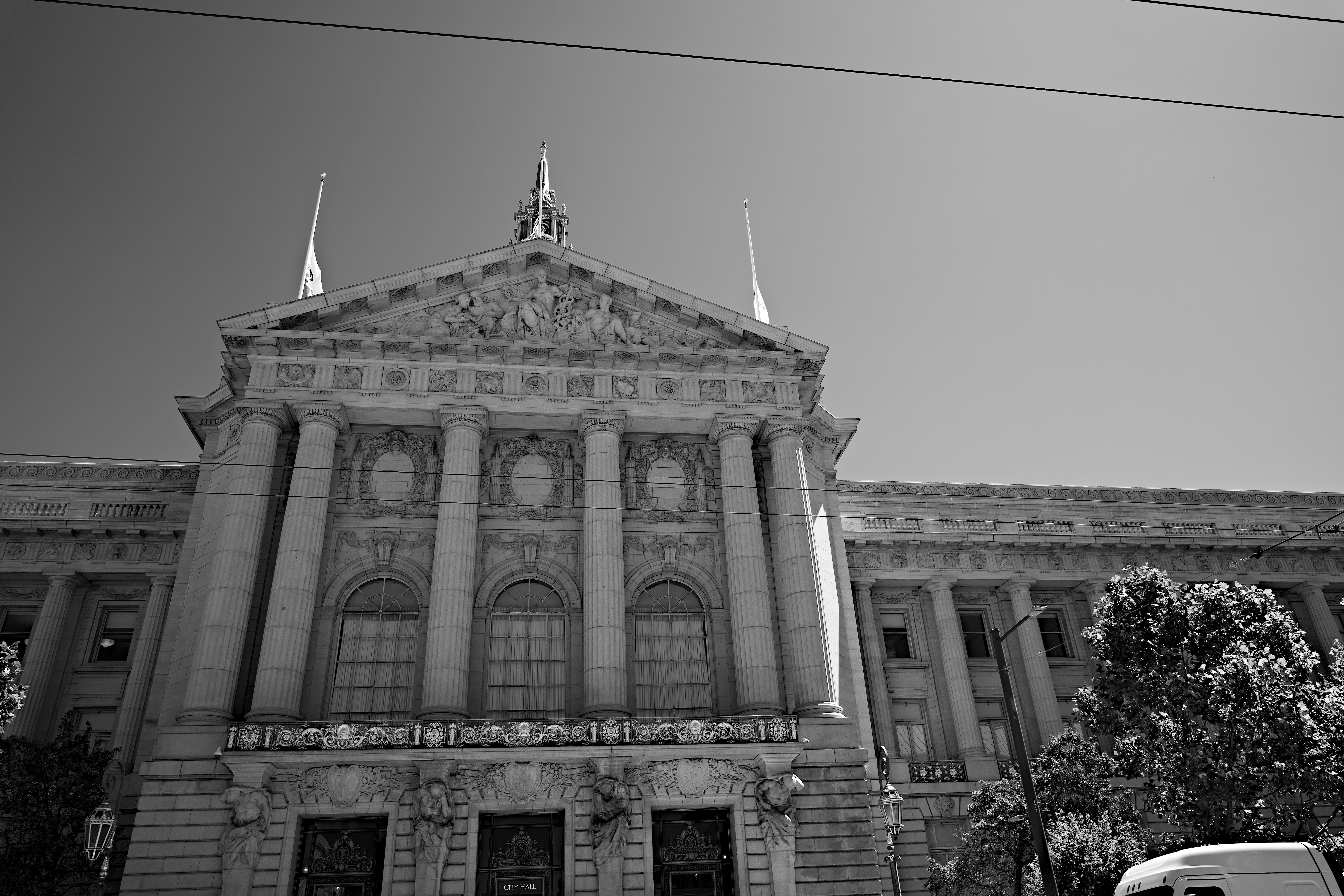 Granite Facade with Classical Columns Under Clear Sky