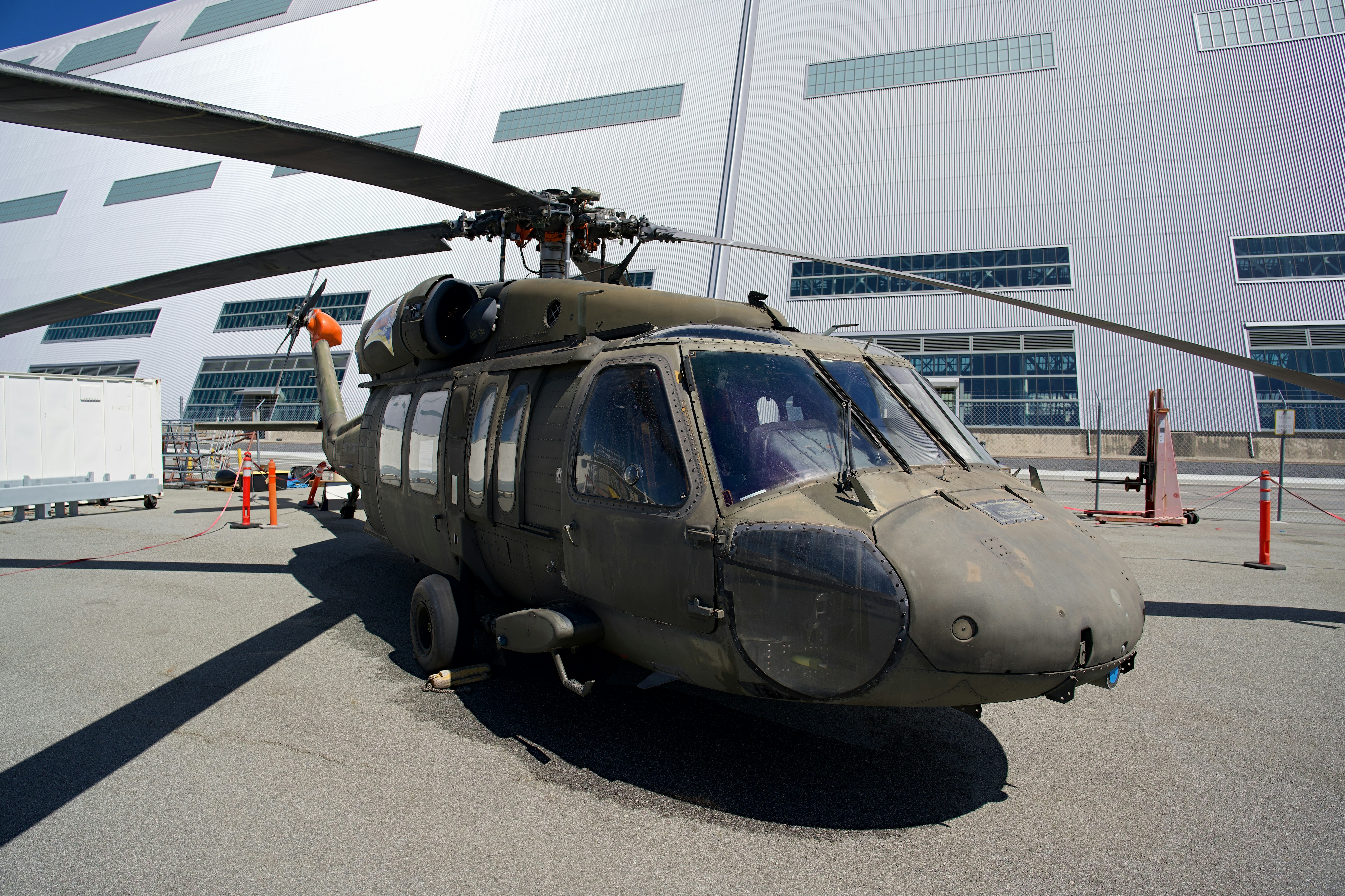 Military Helix: A Weathered Huey resting under sunlit skies