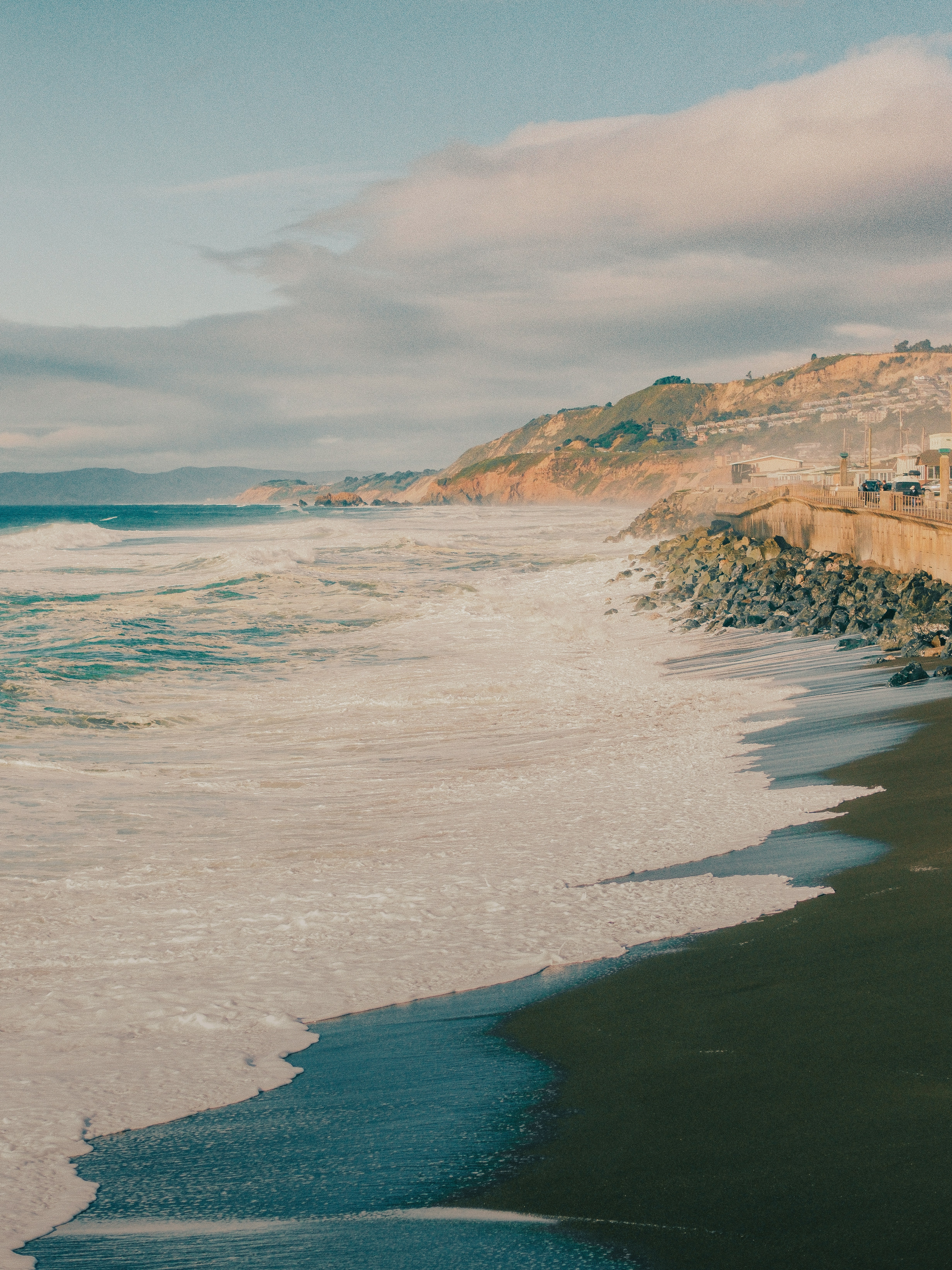 Coastal Roadline: Waves, Rocks, and Golden Cliff