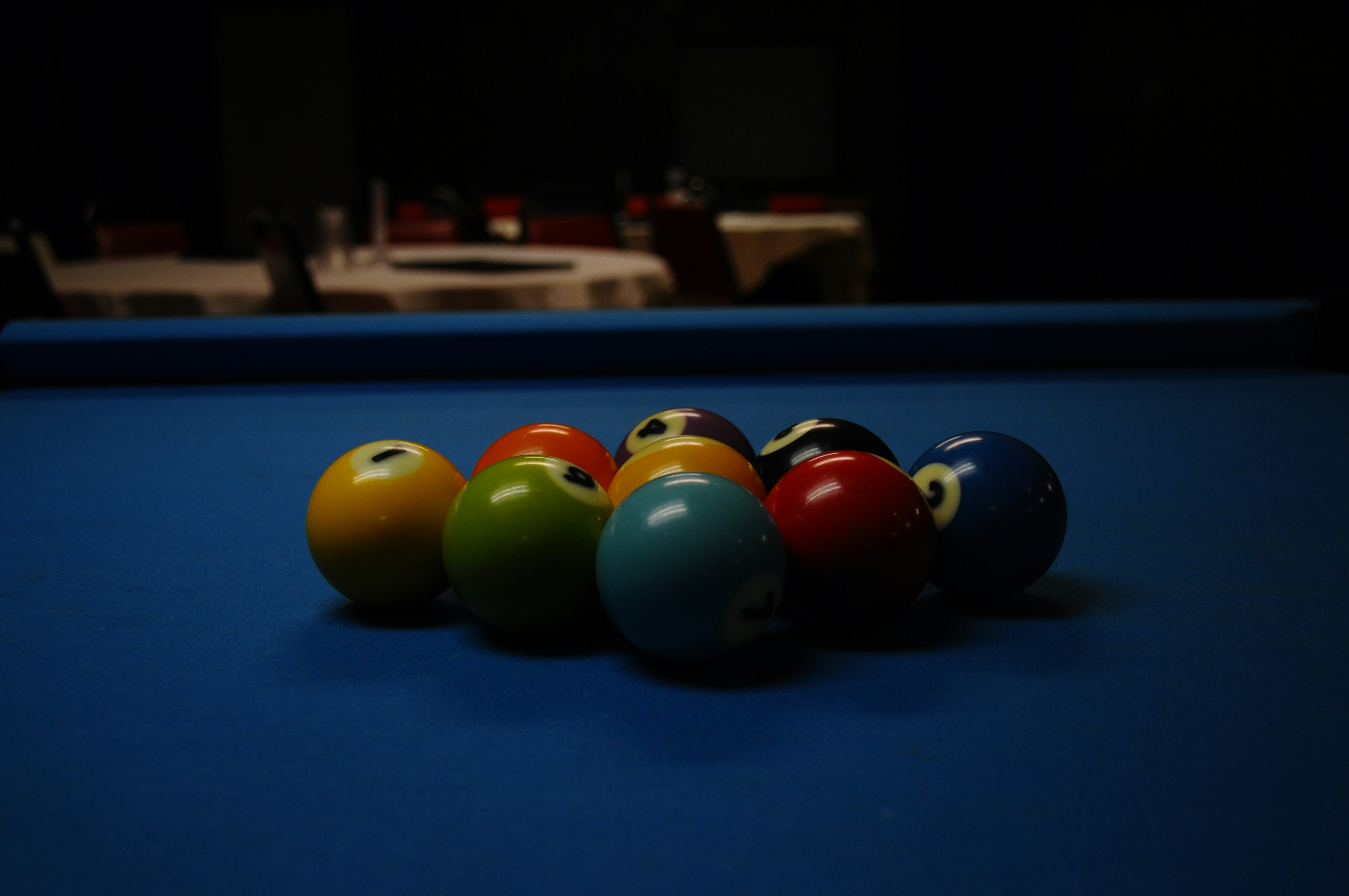 A Quiet Break in the Ragged Blues: Pool Balls Rest in Dim Lights