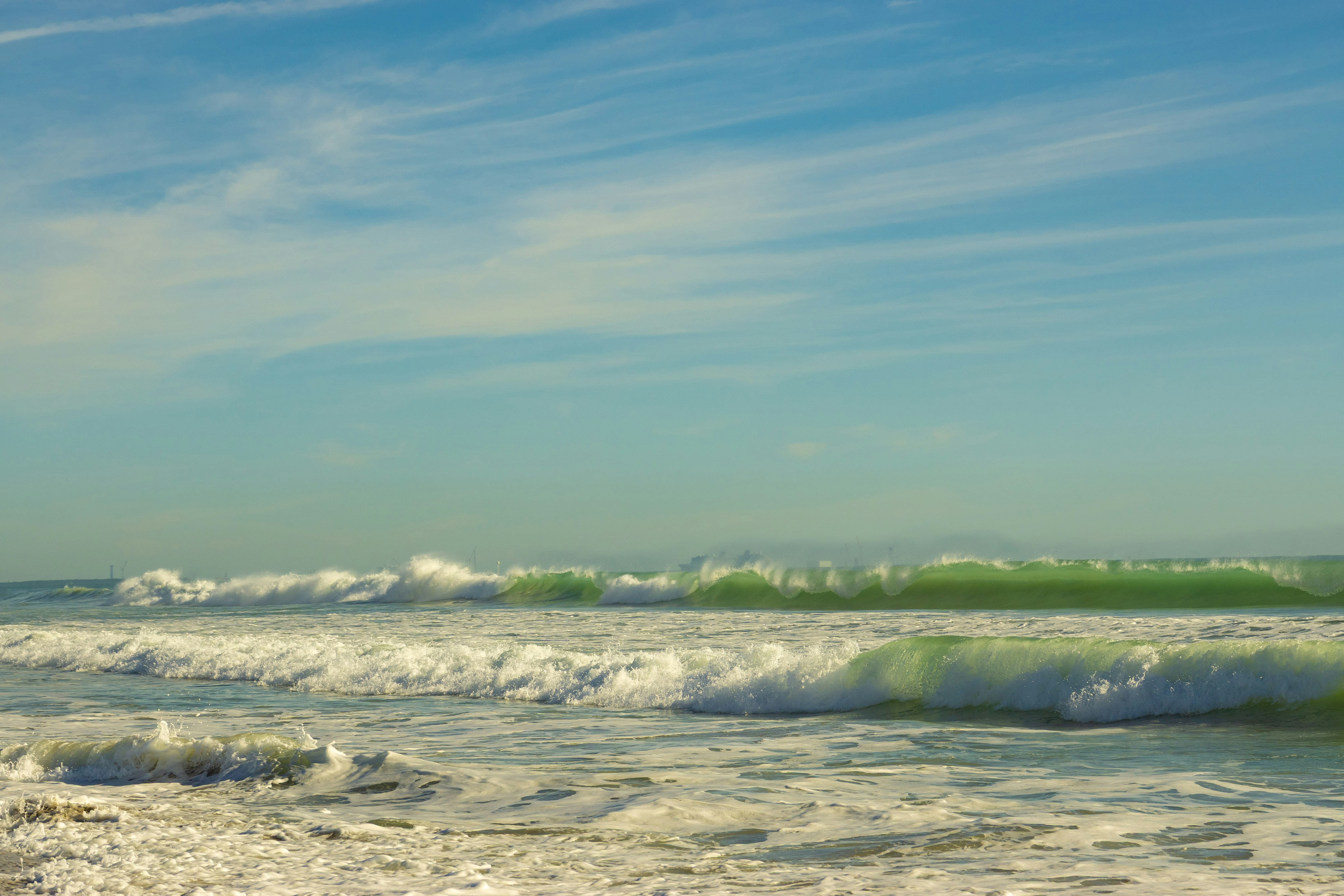 Horizon Glow: Quiet Breakers under a Wide Blue Sky