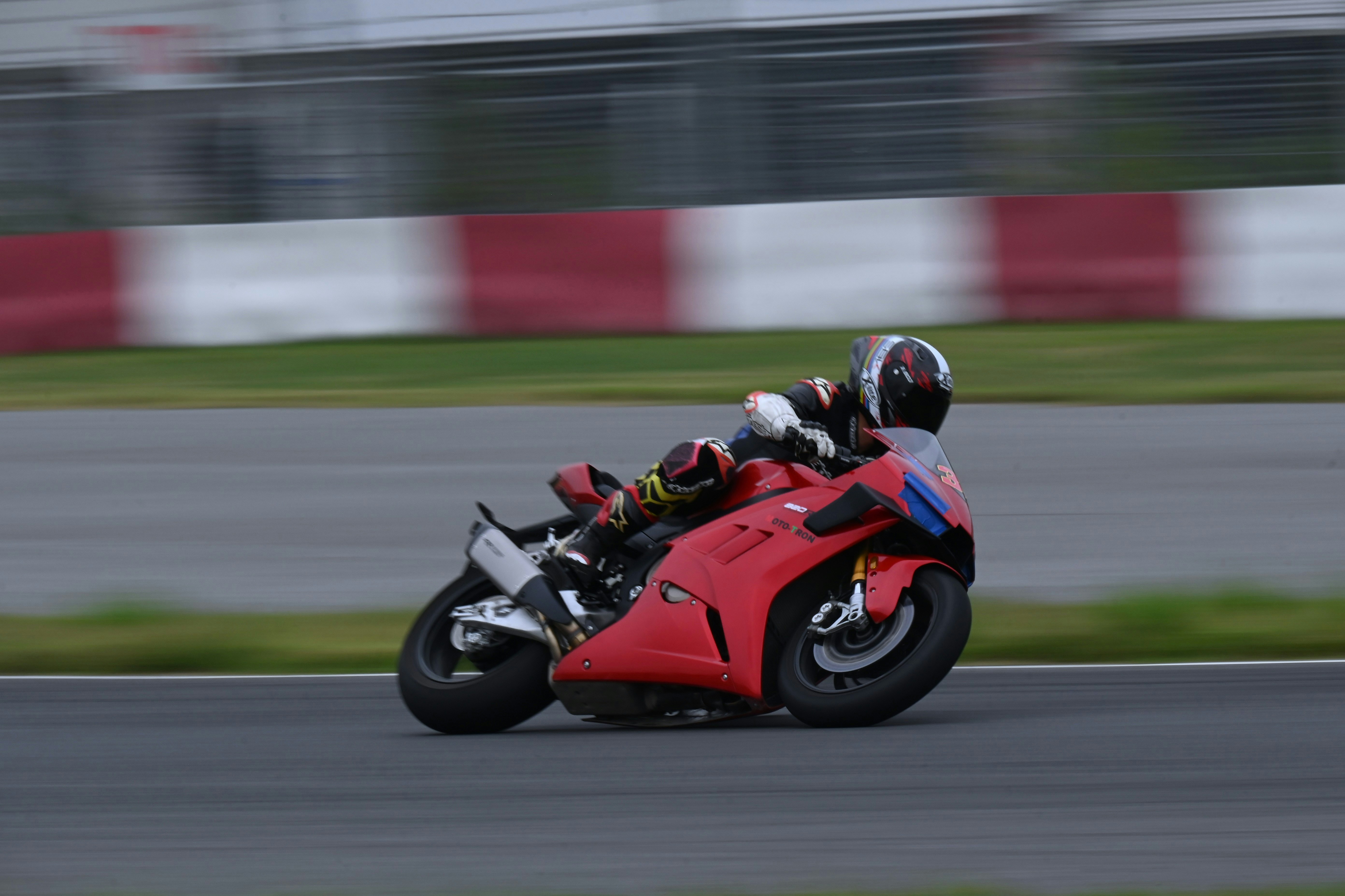 Red Blur: A Rider Leaning into the Turn on Neon-Red sportbike