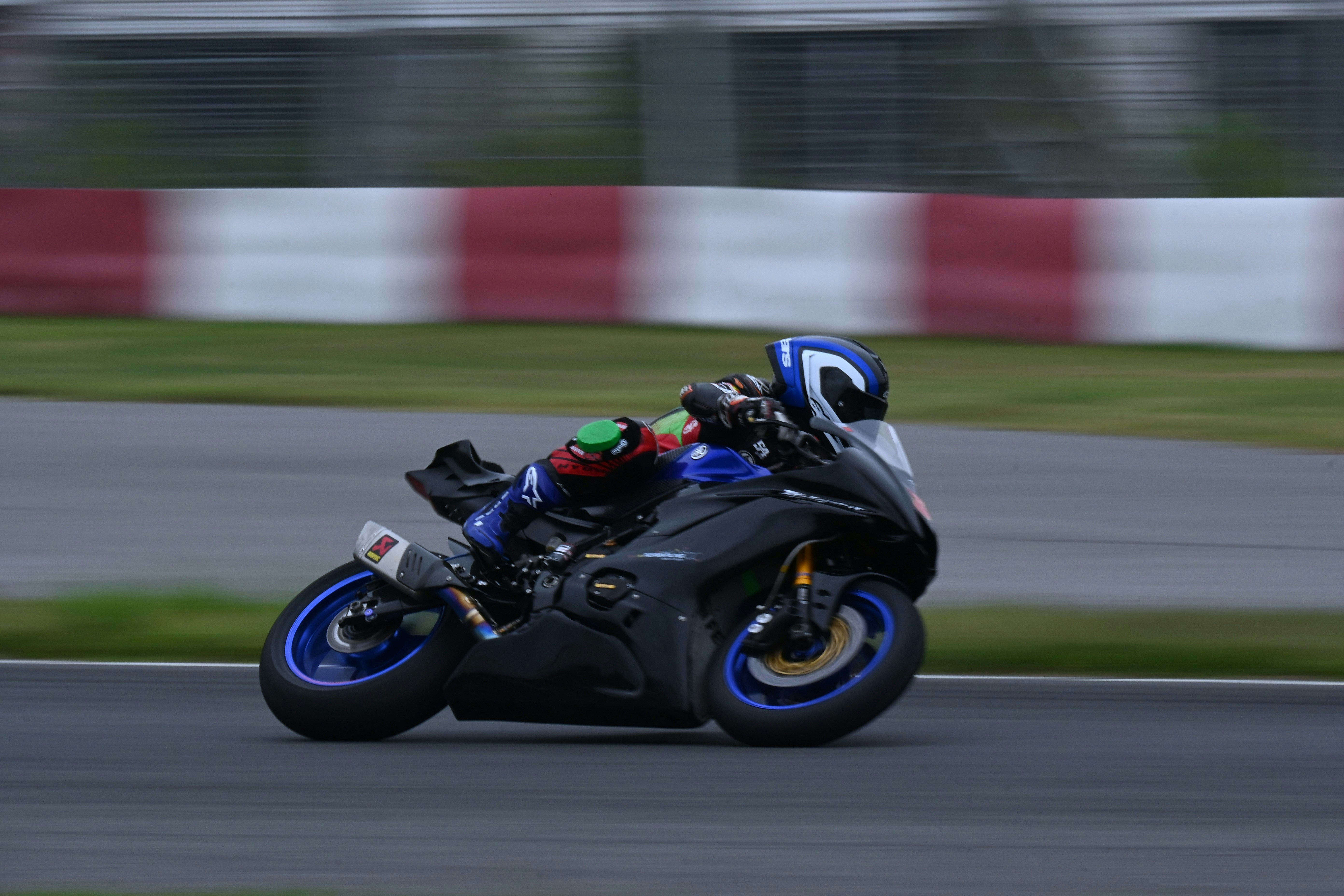 Blue-Rimmed Blur: A Focused Rider in a High-Speed Turn
