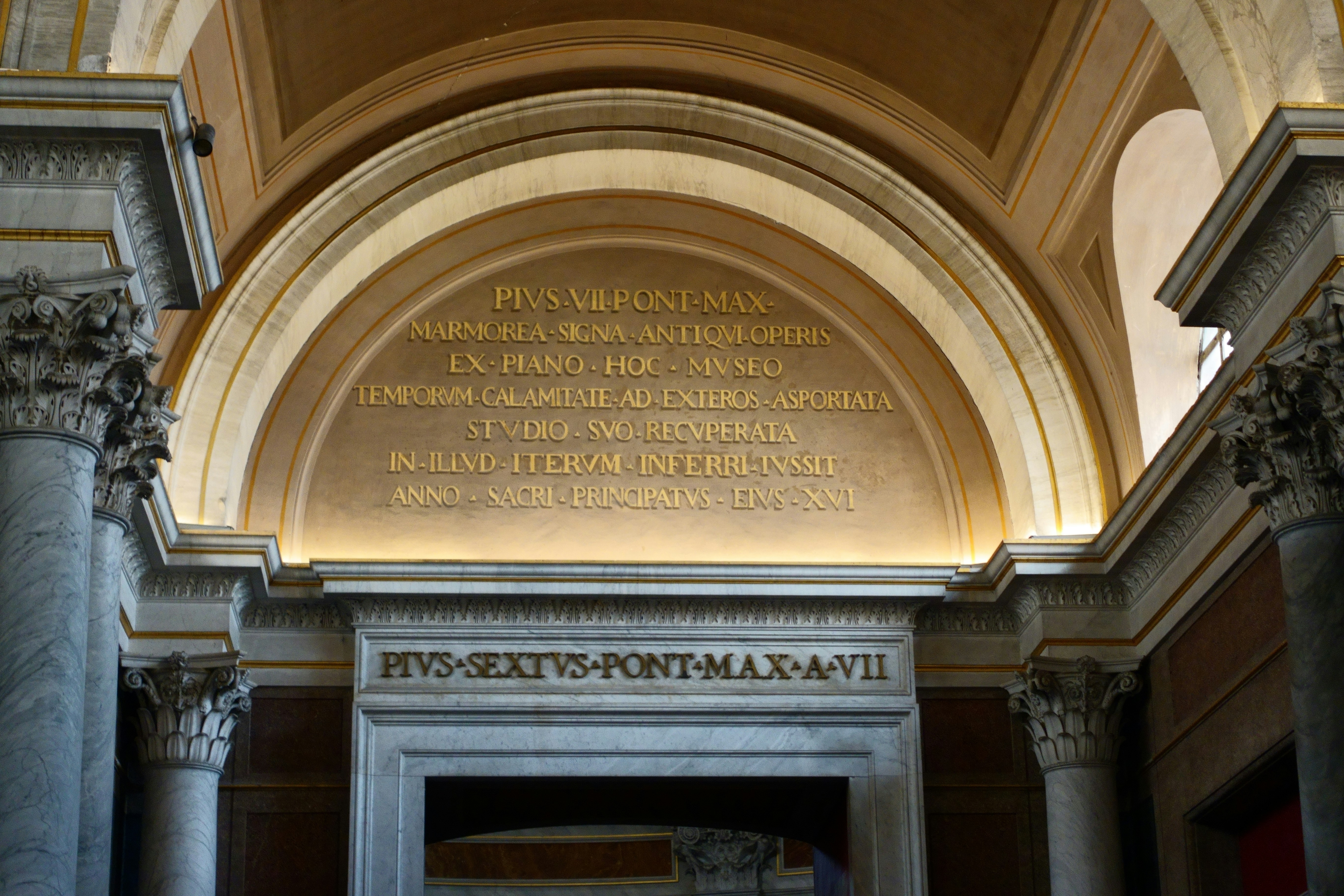 Archway of Dedication: A Classical Inscription Centered Under Golden Arch