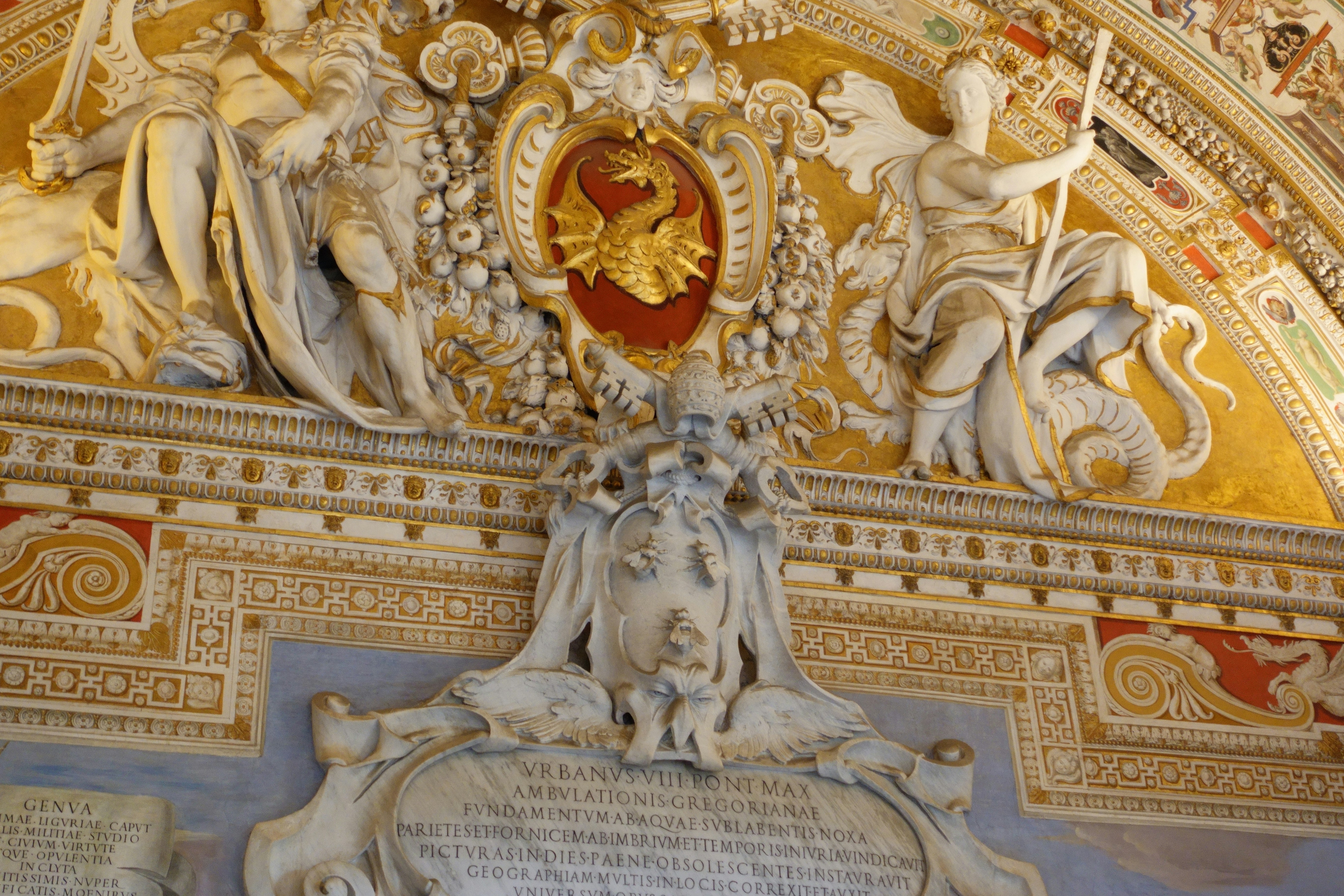 Golden Relief: Sculpted Crest and Figures Above the Inscribed Tablet