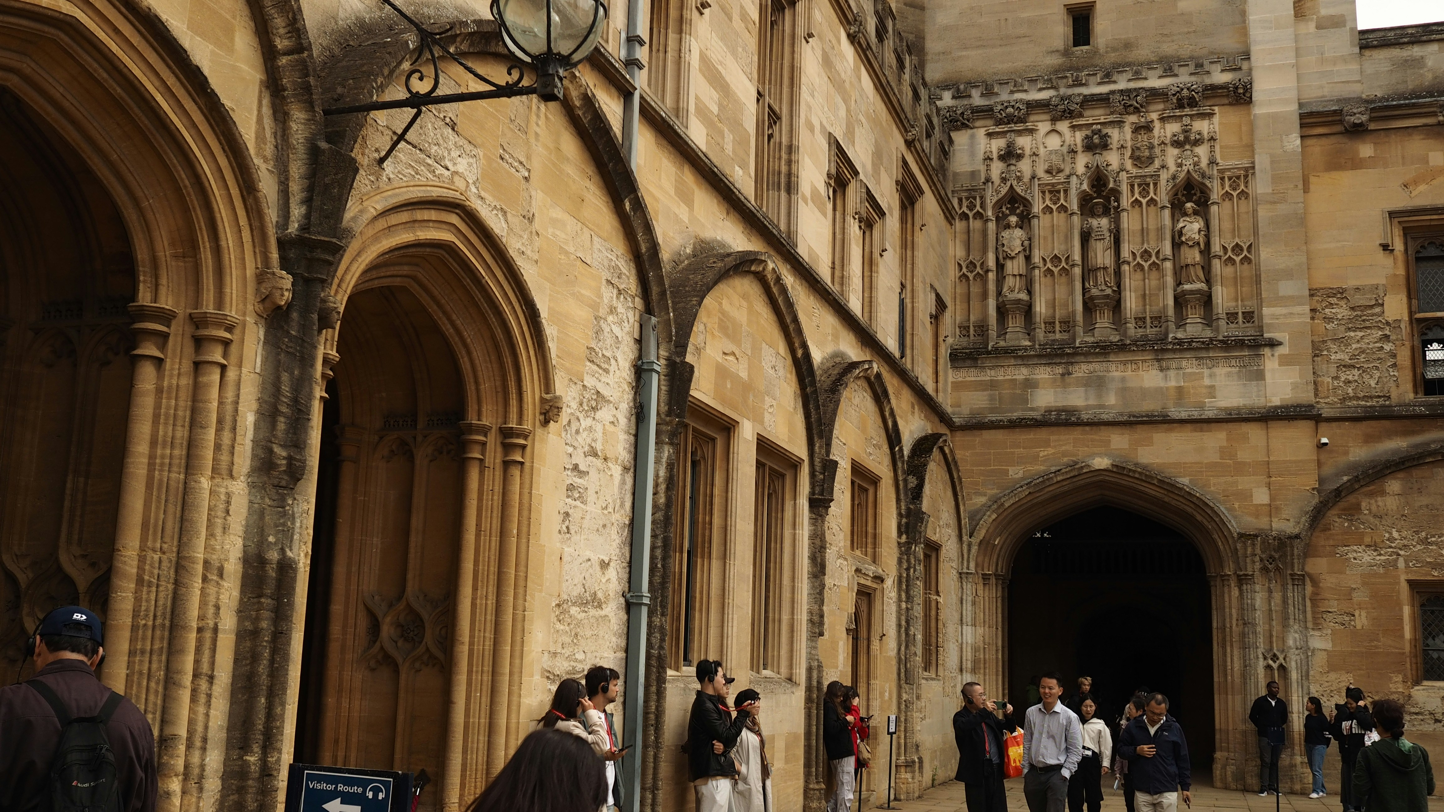 Courtyard Arches and Passage: People Gather at a Historic University Cloister