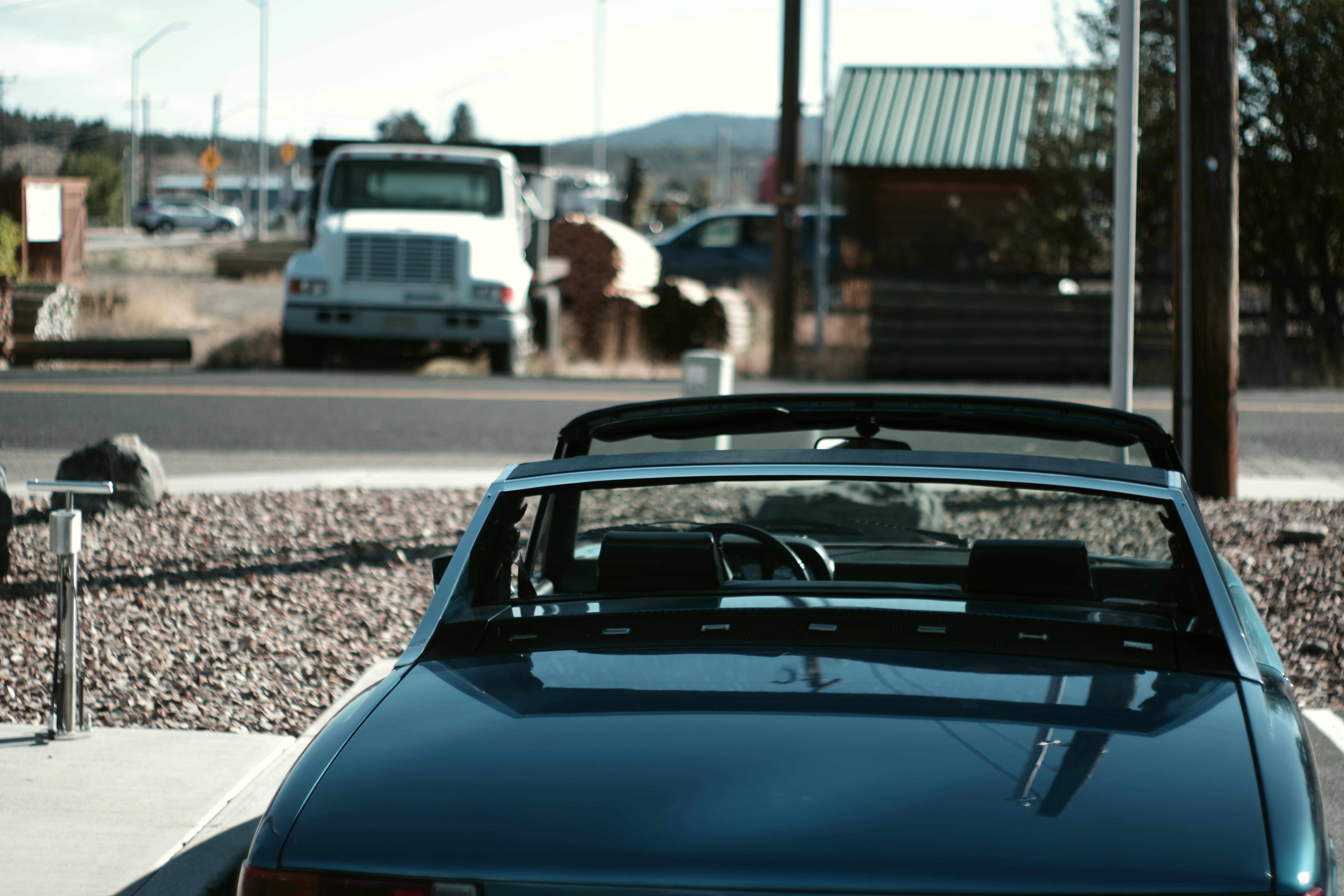 Open-Top Classic: The Blue Convertible Grounded in a Quiet Lot