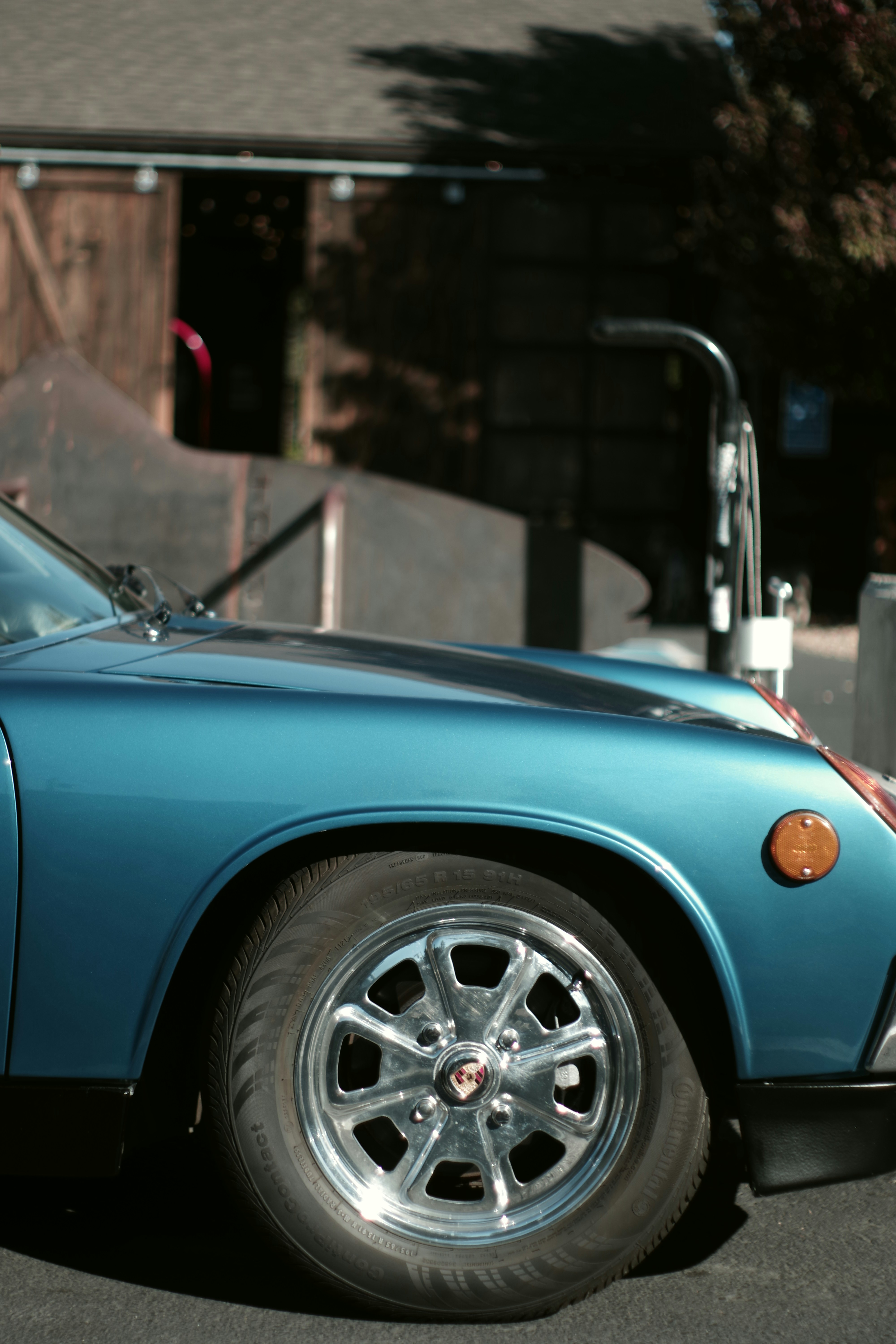 Aqua Classic: chrome wheel and satin blue curves under daylight