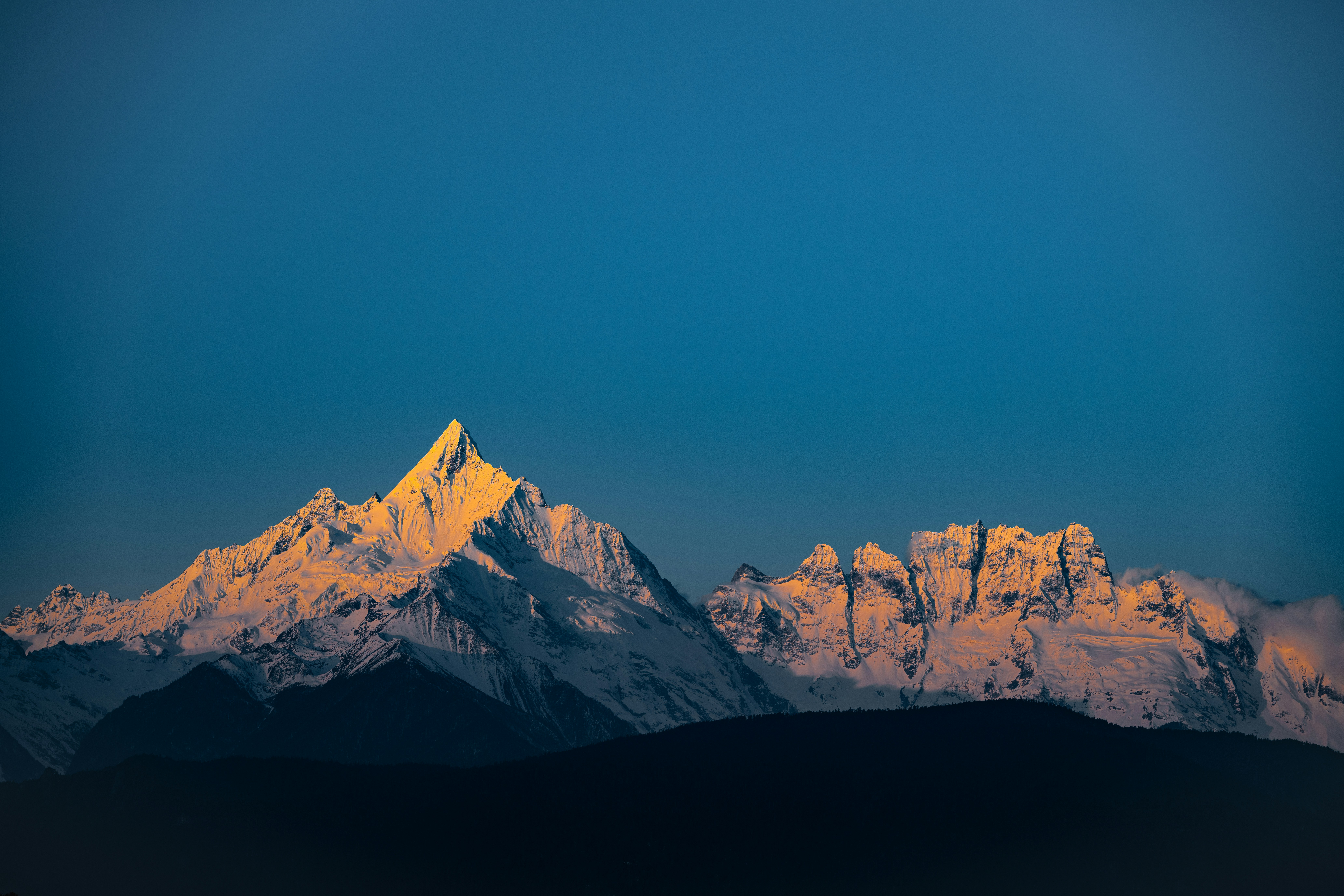 First Light on the Spine: Snow-Crowned Peak