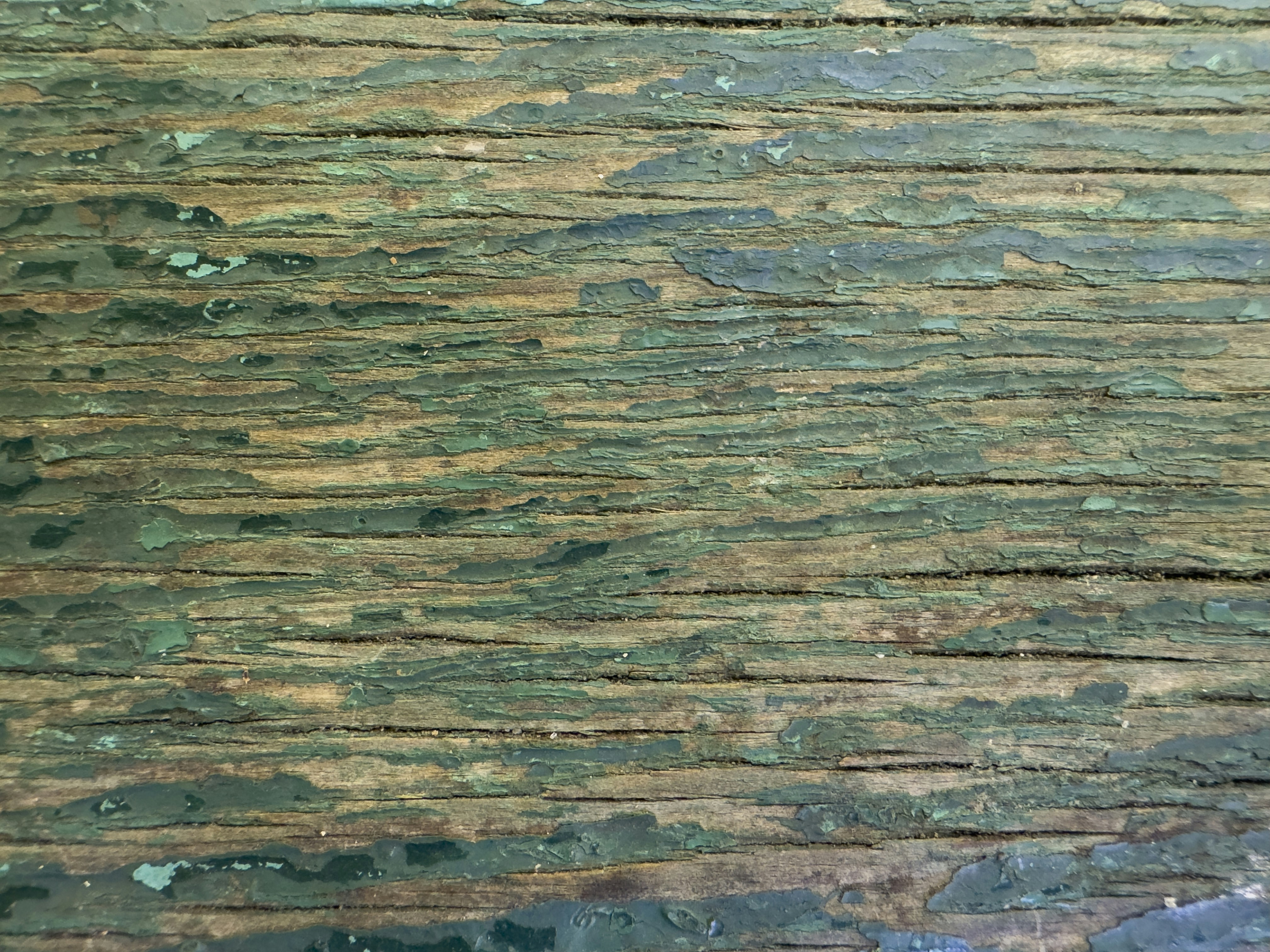 Weathered Grain: Close-Up of Aging Green-Blue Wood Planks