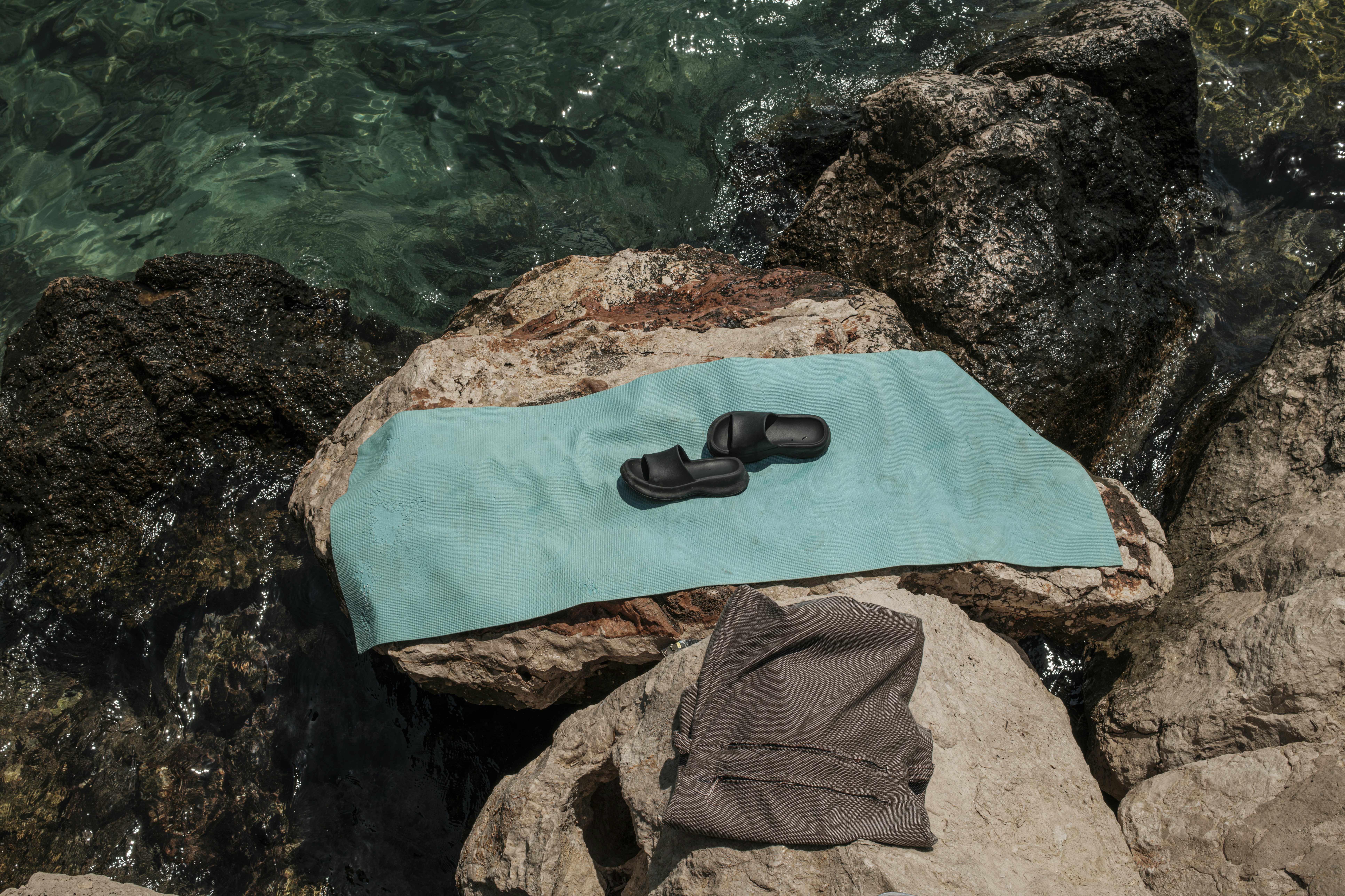Summer beach essentials on rocky shoreline