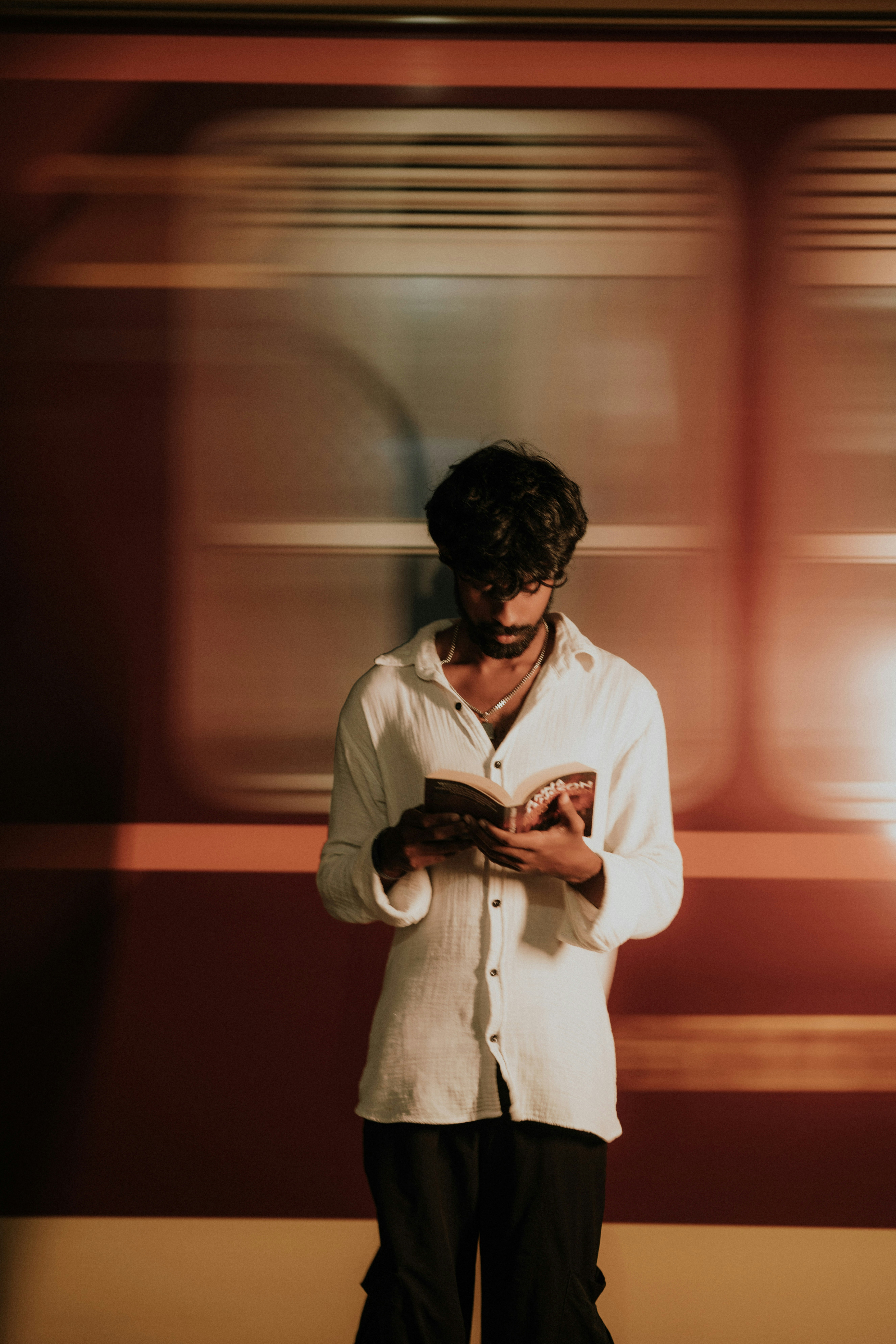 Reader on a Moving Subway: Quiet Focus Amid Blur