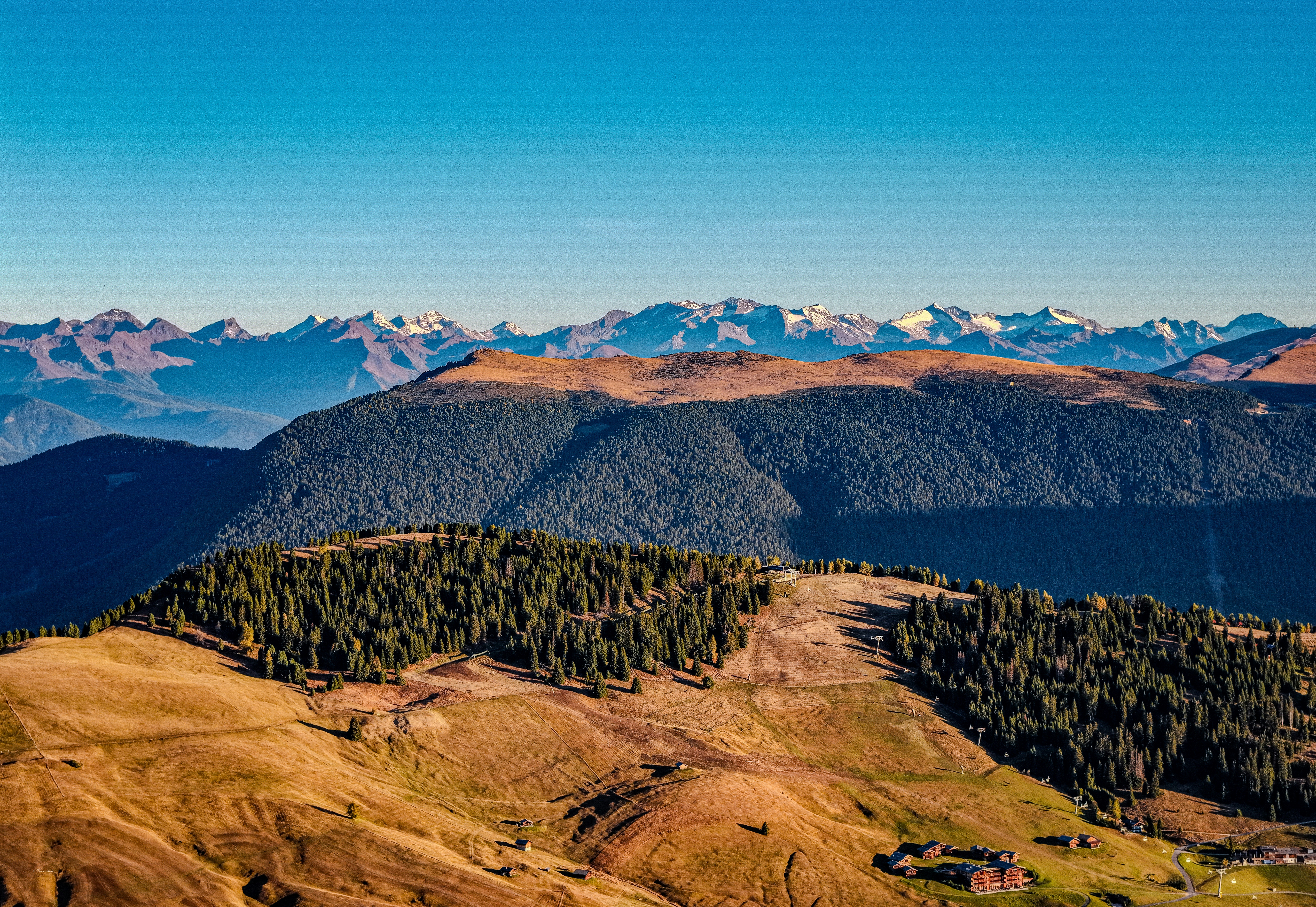 Aerial Crest: Alpine Ridge Beneath a Clear Blue Vista