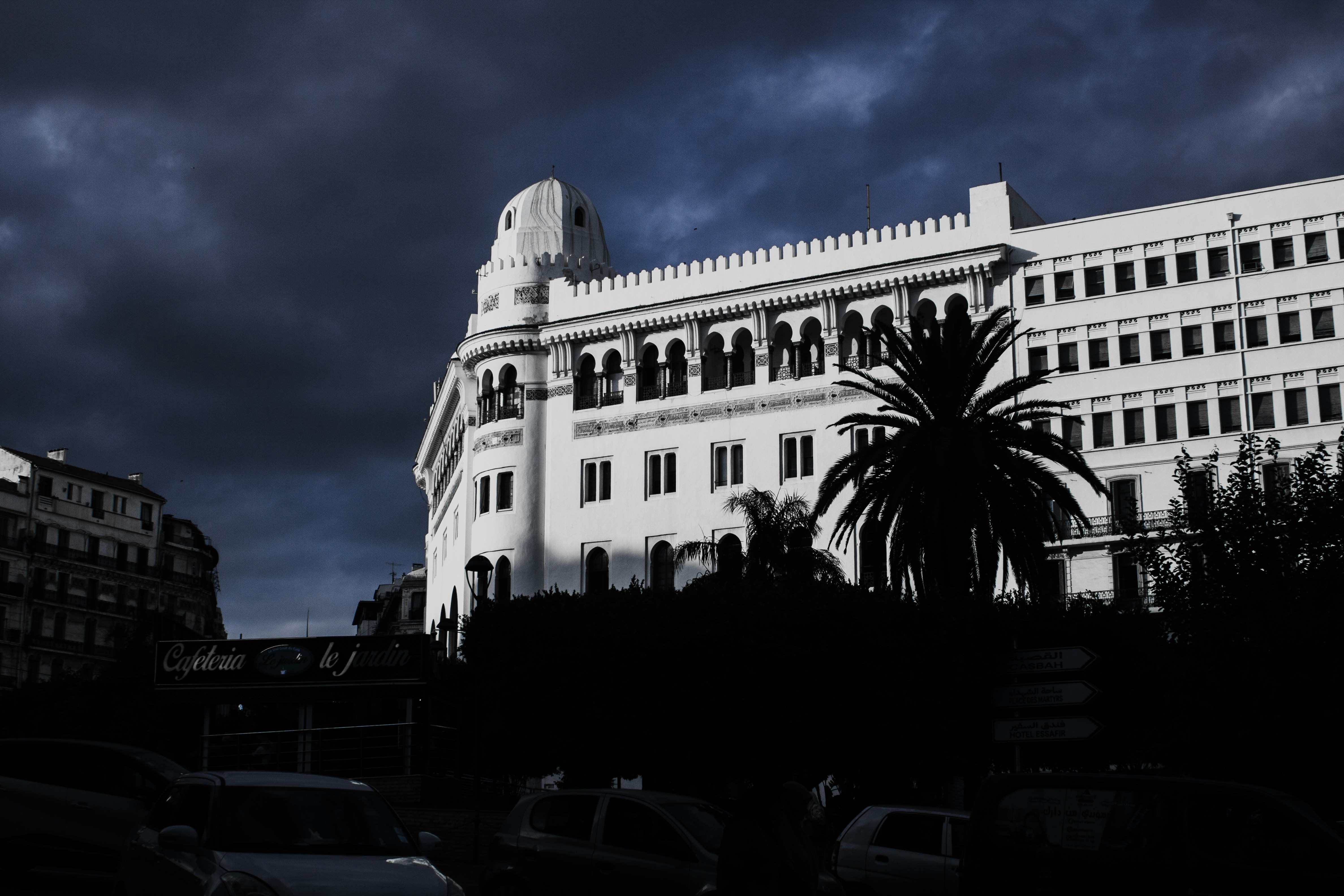 Sunlit Forte: A Neo-Classical Facade Under Storm’s Edge
