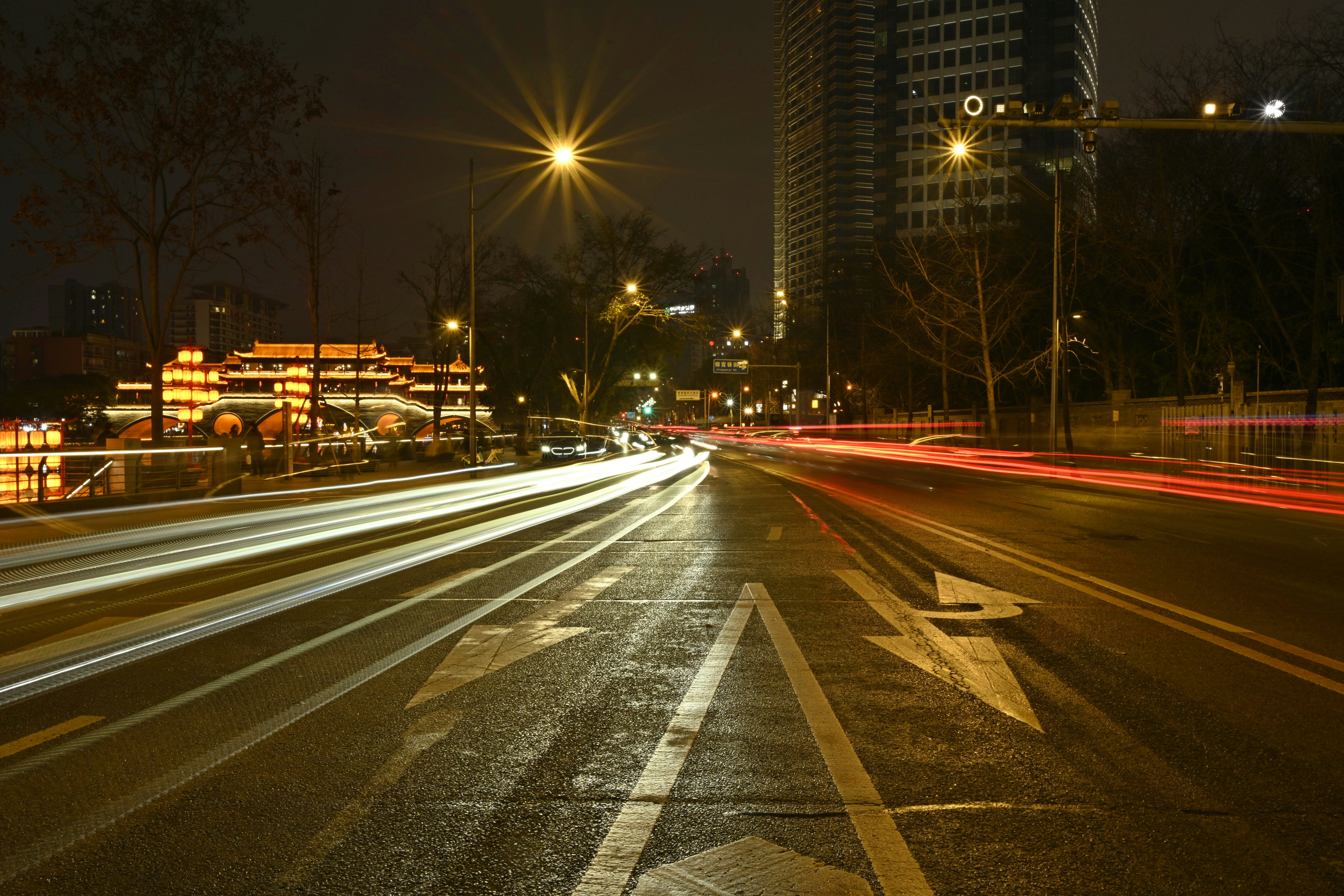 Night Corridor: Car Lights Weave Through a City Street